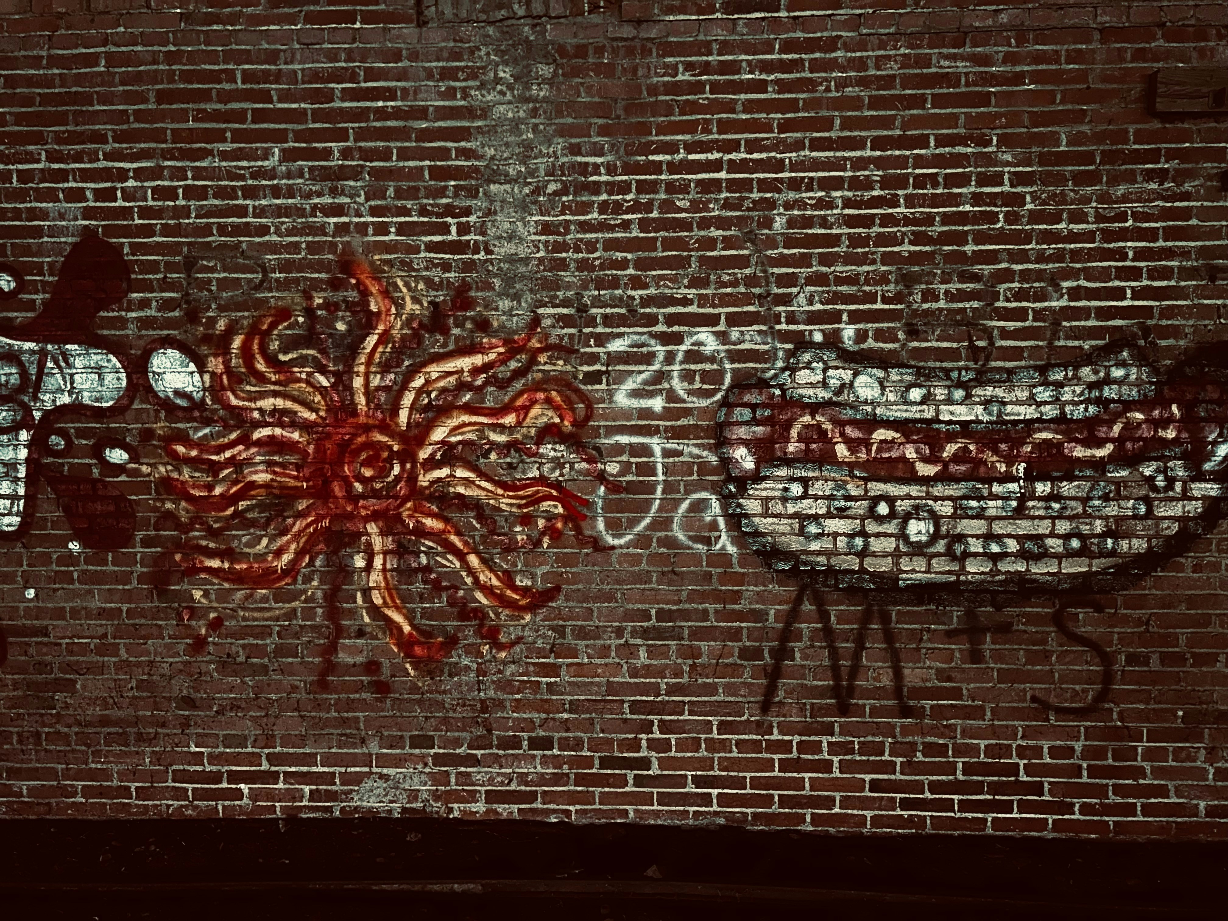 Sunburst of Open Flame Graffiti on Brick Wall