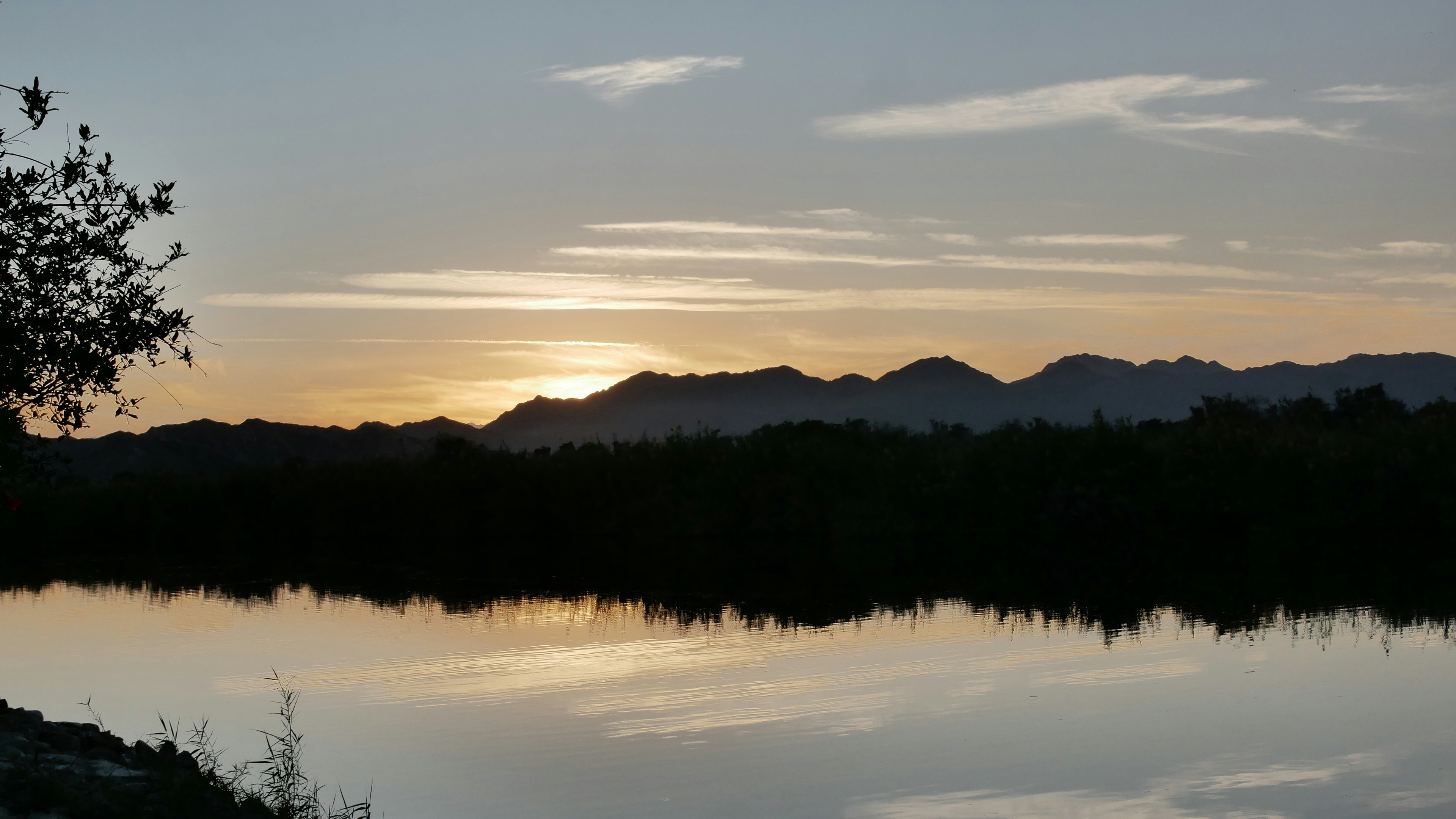 Golden Horizon Reflected: Quiet Sunset Over a Valley Lake