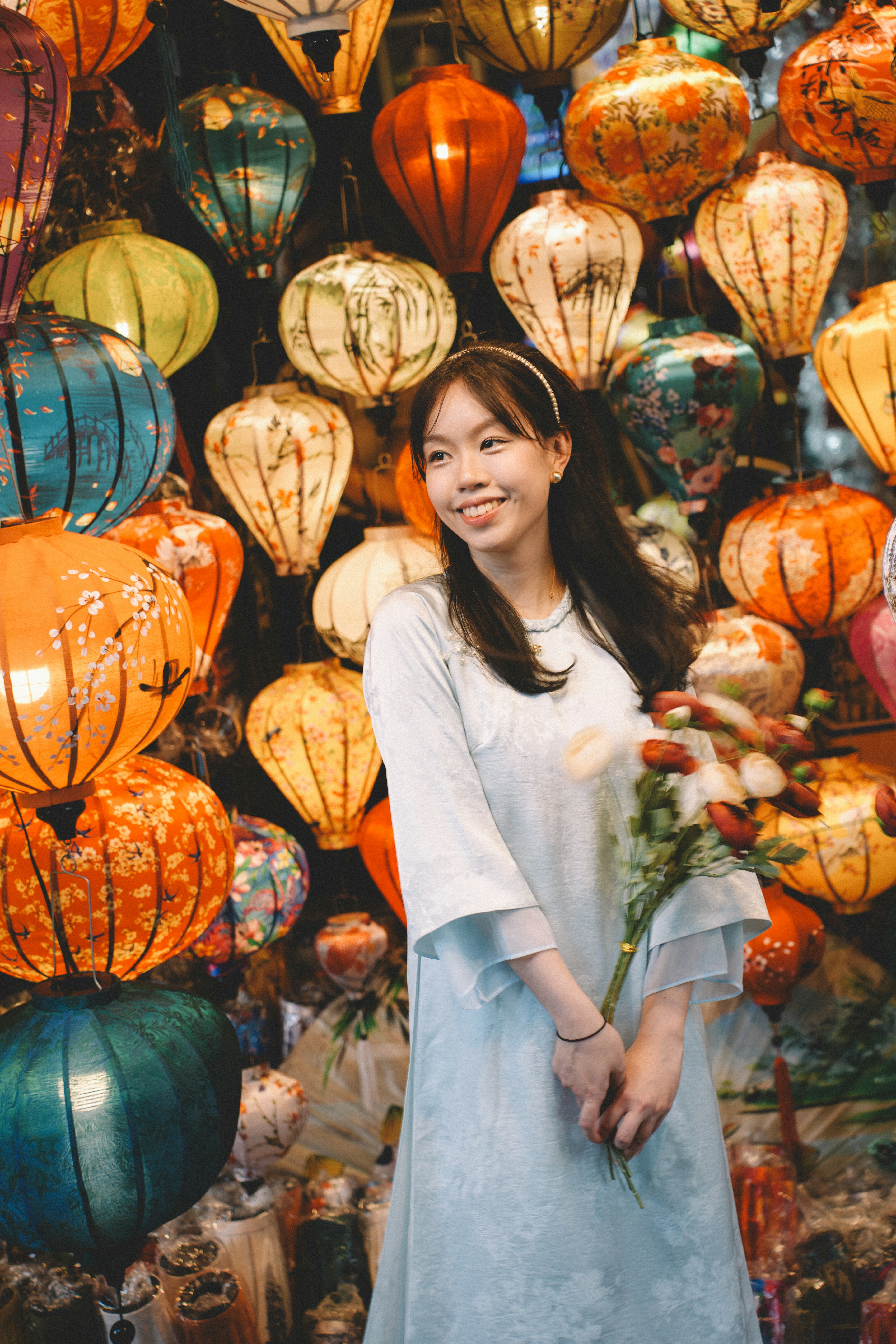 Soft smile among lanterns: a portrait in a sea of lantern glow