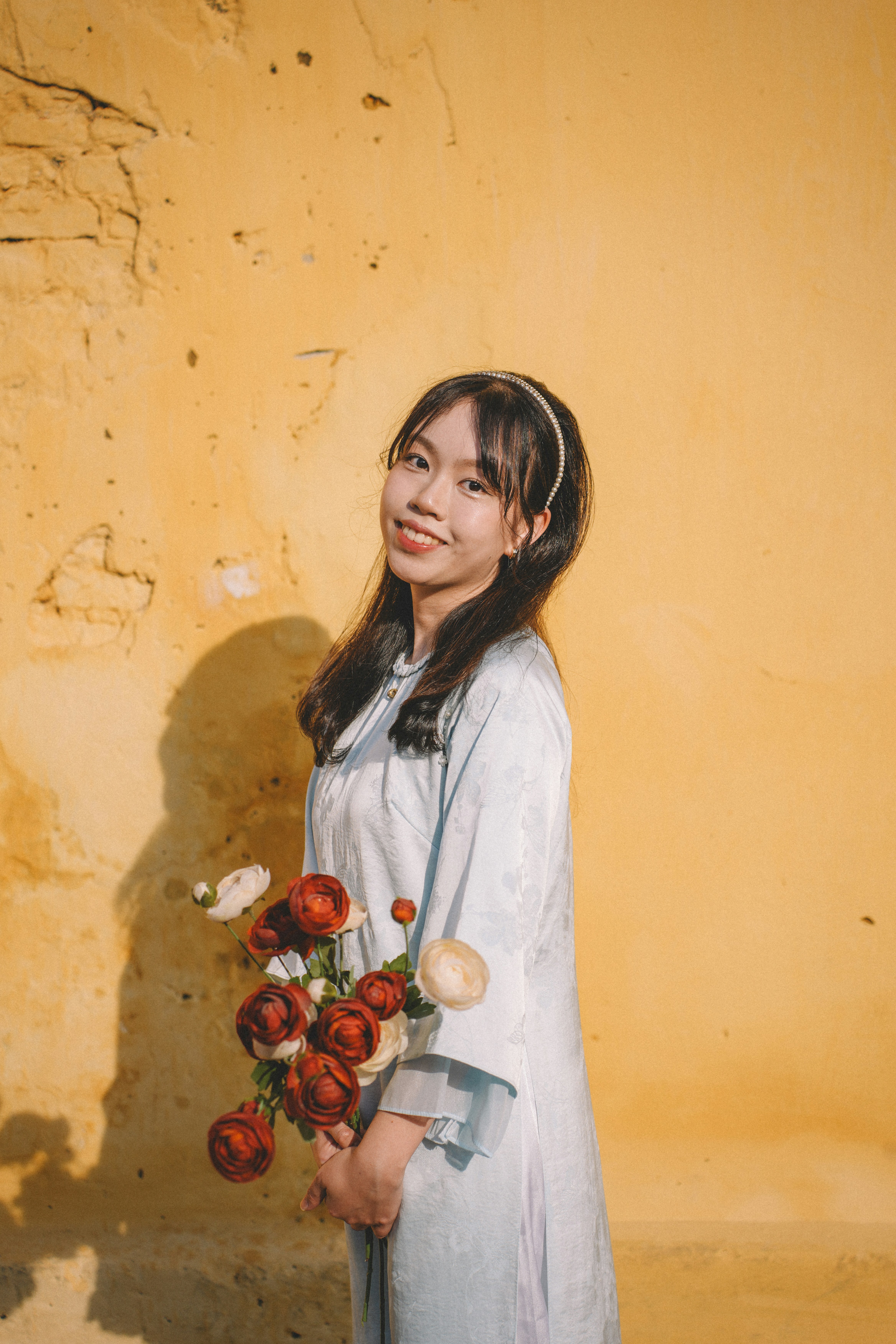 Sunlit Bouquets: A Quiet Smile Against Sunlit Stucco