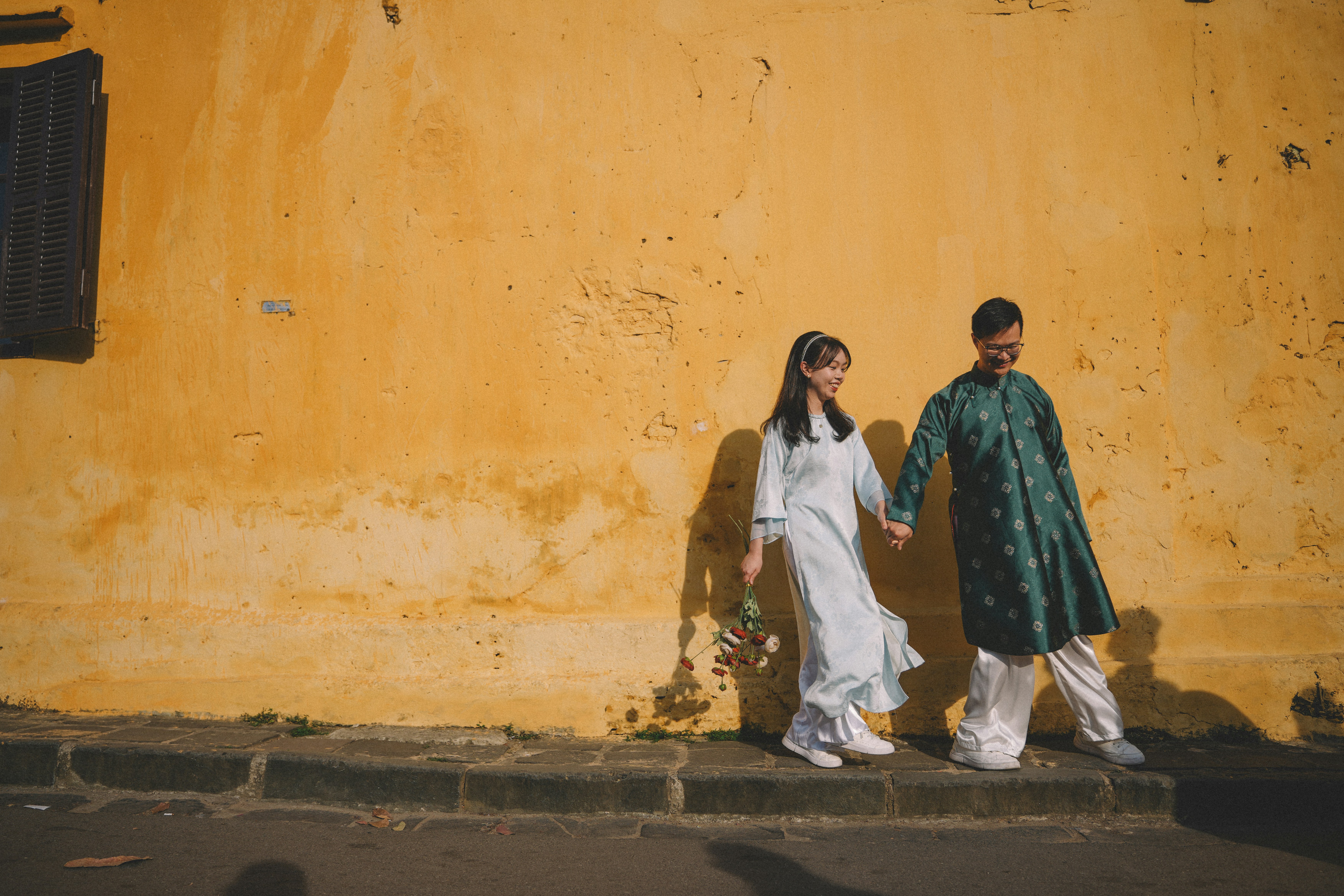 Golden Wall Embrace: A Quiet Moment Between Partners