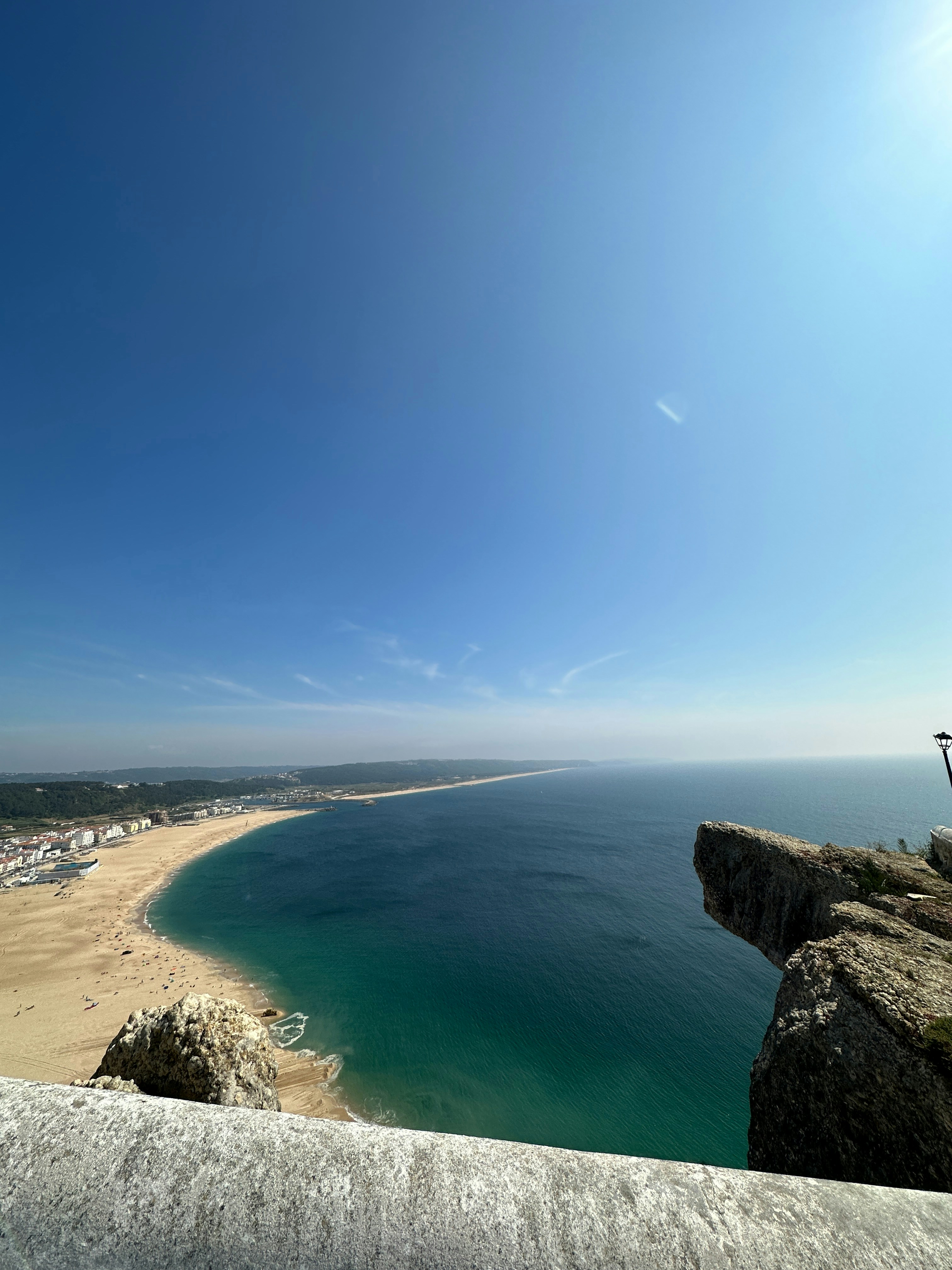 Edge of the World: Cliffside View Over a Curving Beach