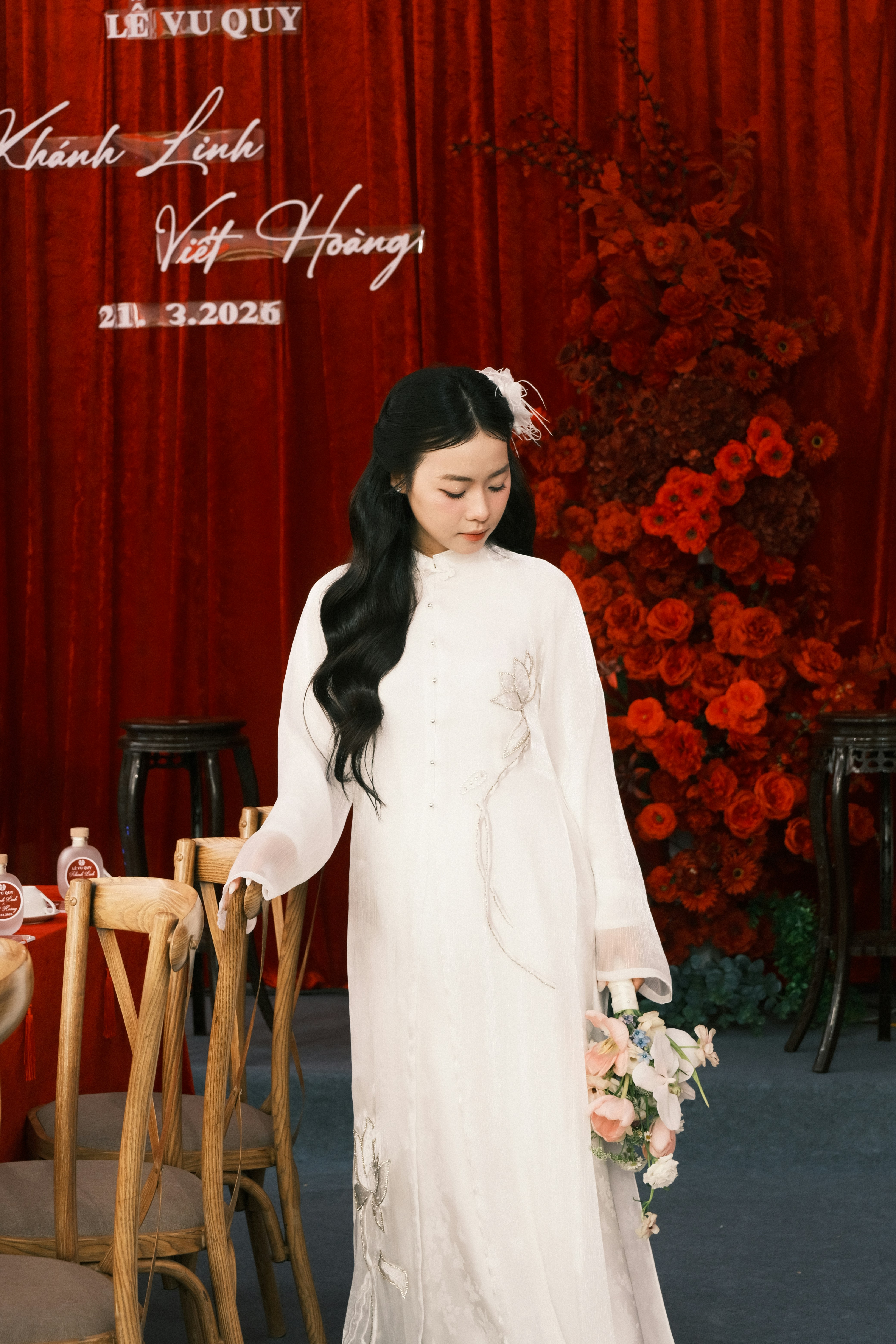 Bride in White Ao Dai Beneath Crimson Backdrop