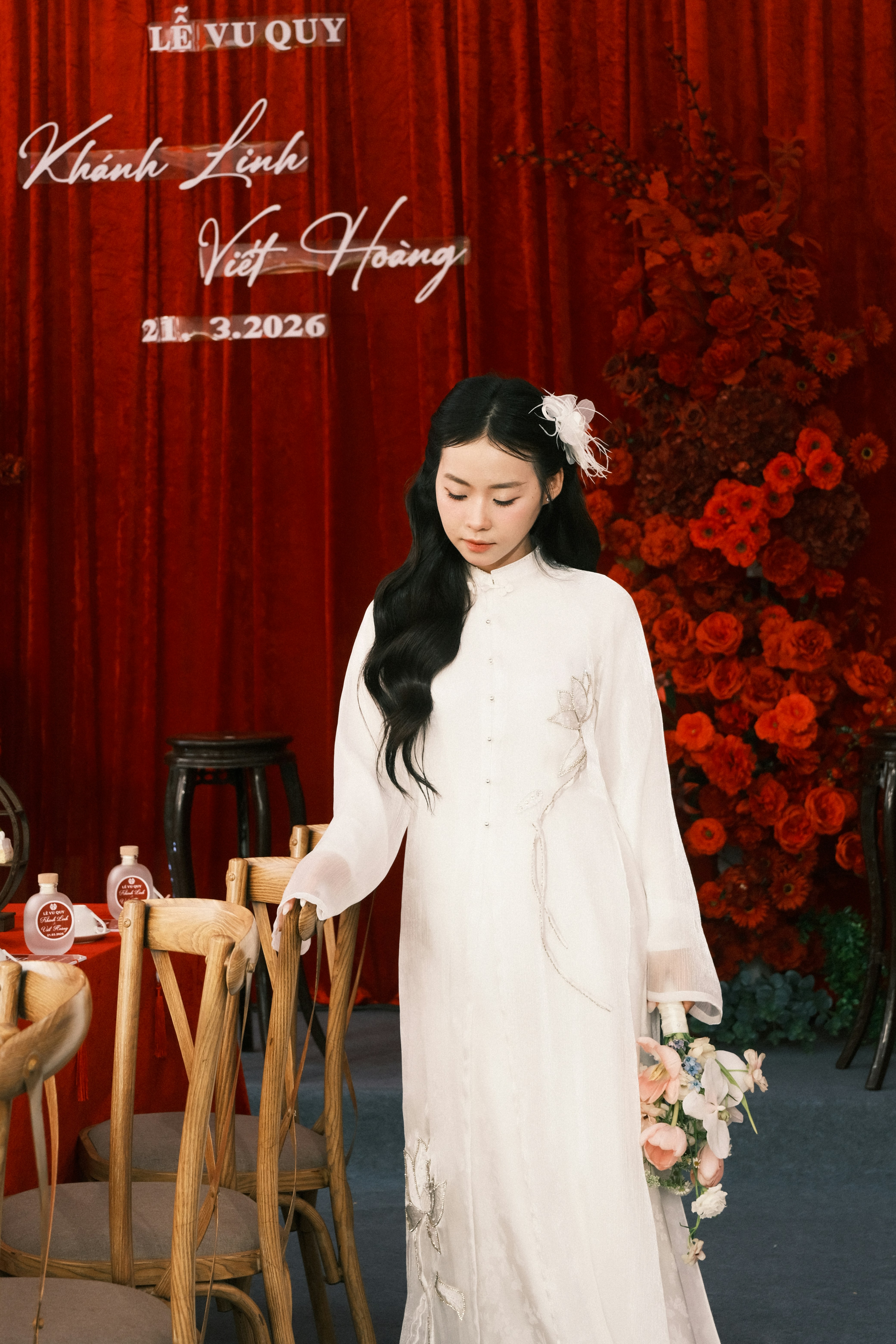 Bride in White Ao Dai Beneath Crimson Backdrop