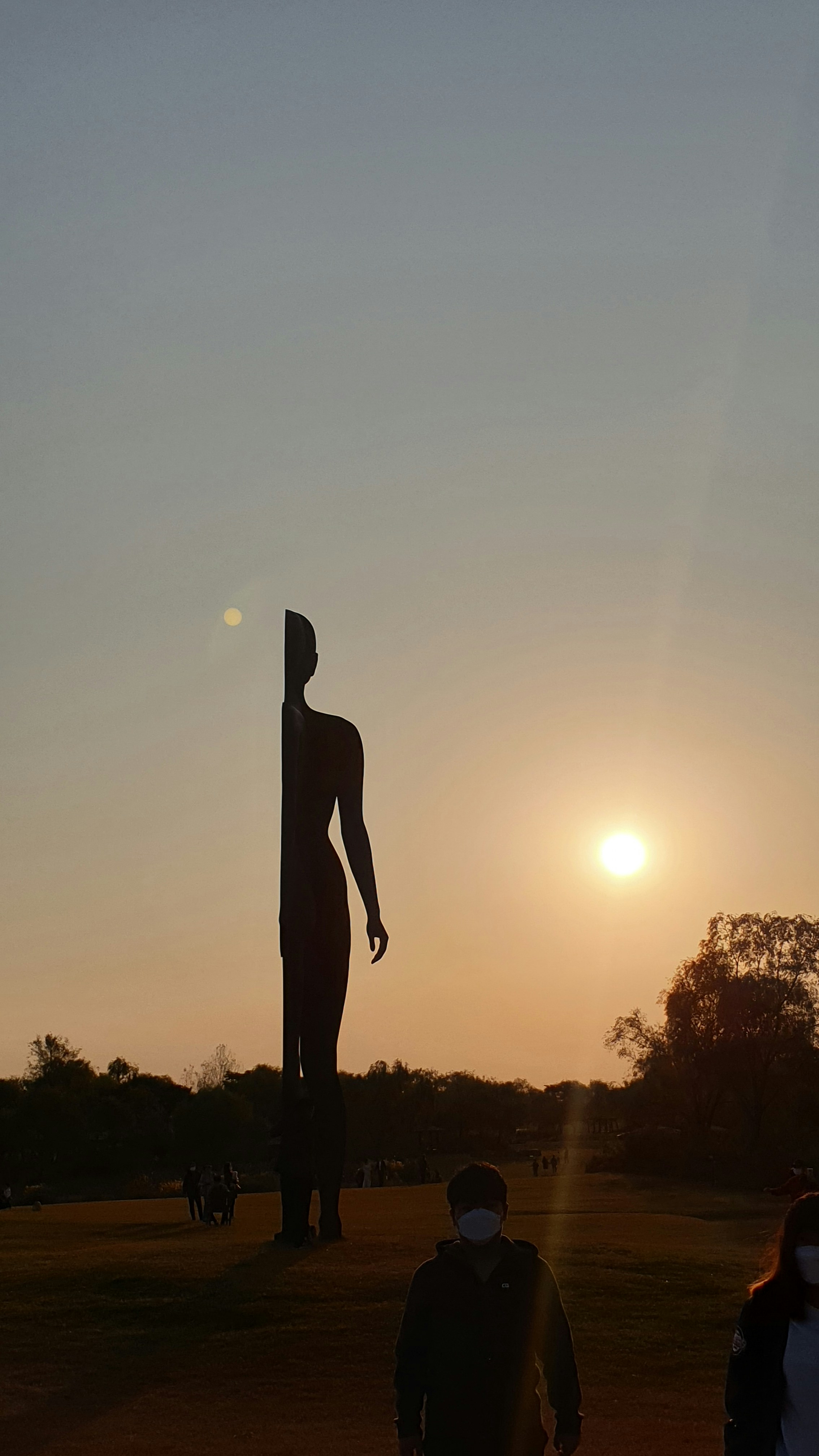Sunset Silence: A Quiet Moment with a Tall Silhouette
