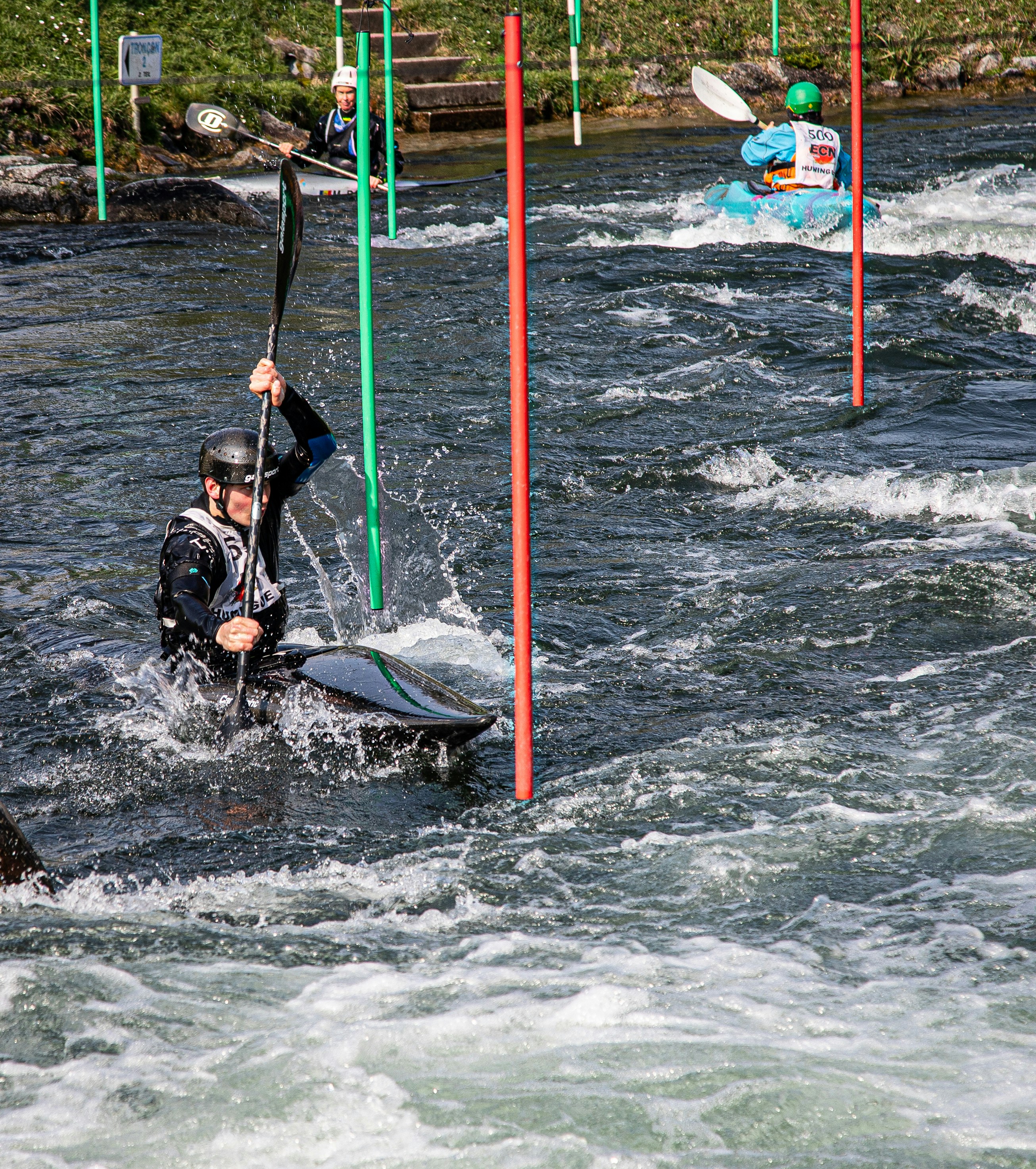 Rapid Ascent: Kayakers Navigating Rolling Gates
