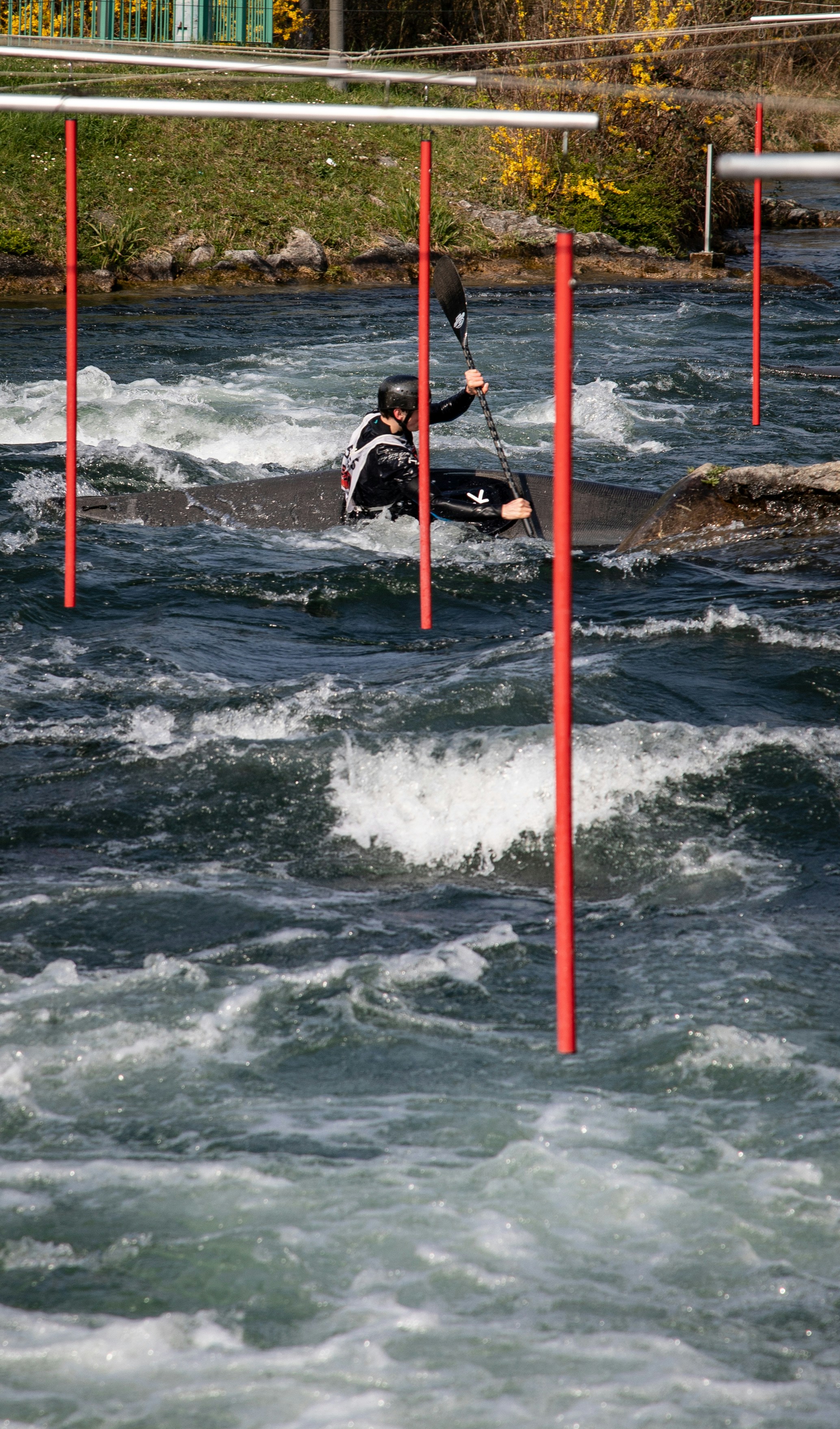 Racing through Whitewater: A Kayaker Navigates Downriver Gates