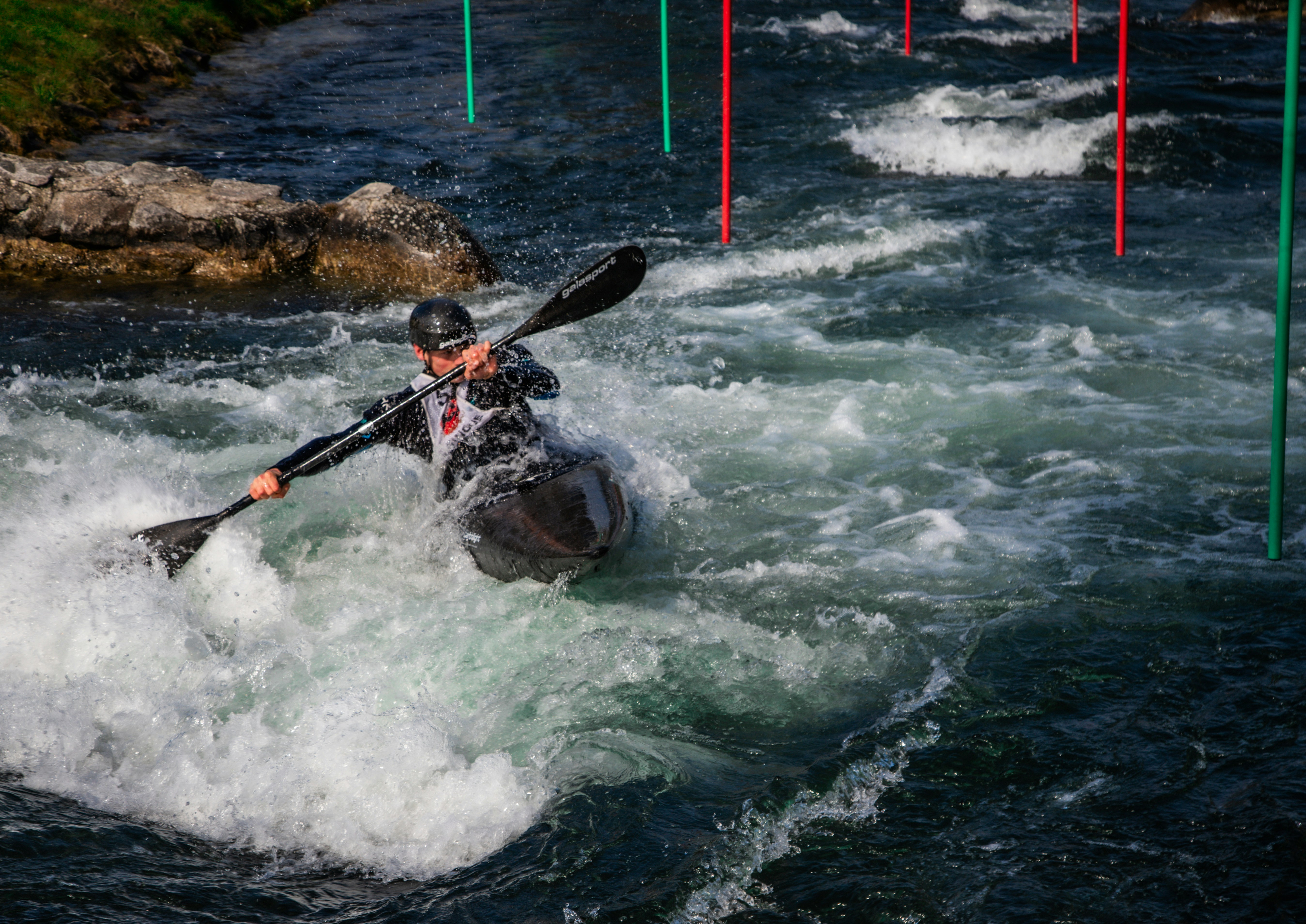 Whitewater Focus: Kayaker Charging Through River Surf