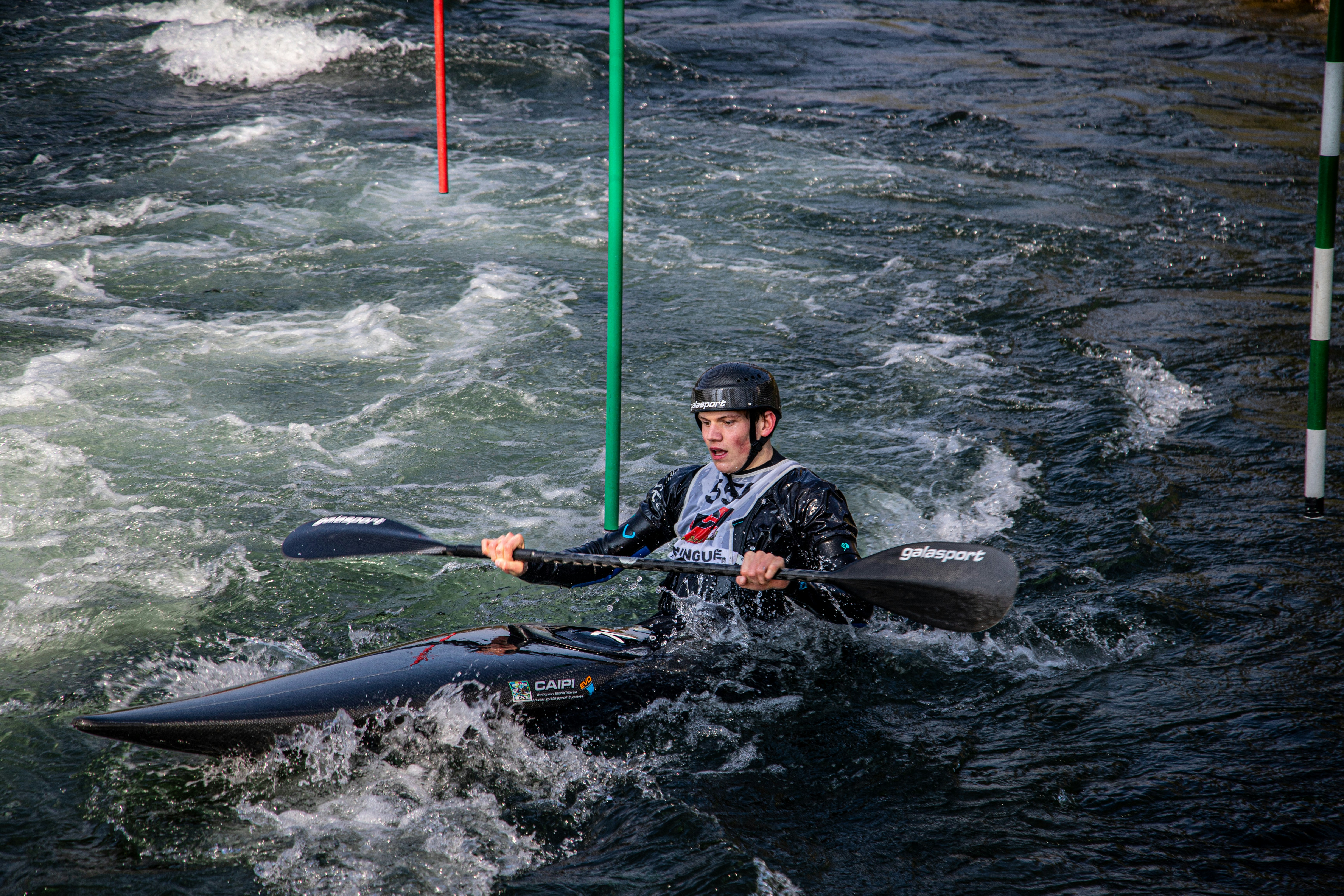 Race Against the Current: Kayaker Navigates Slalom Gates