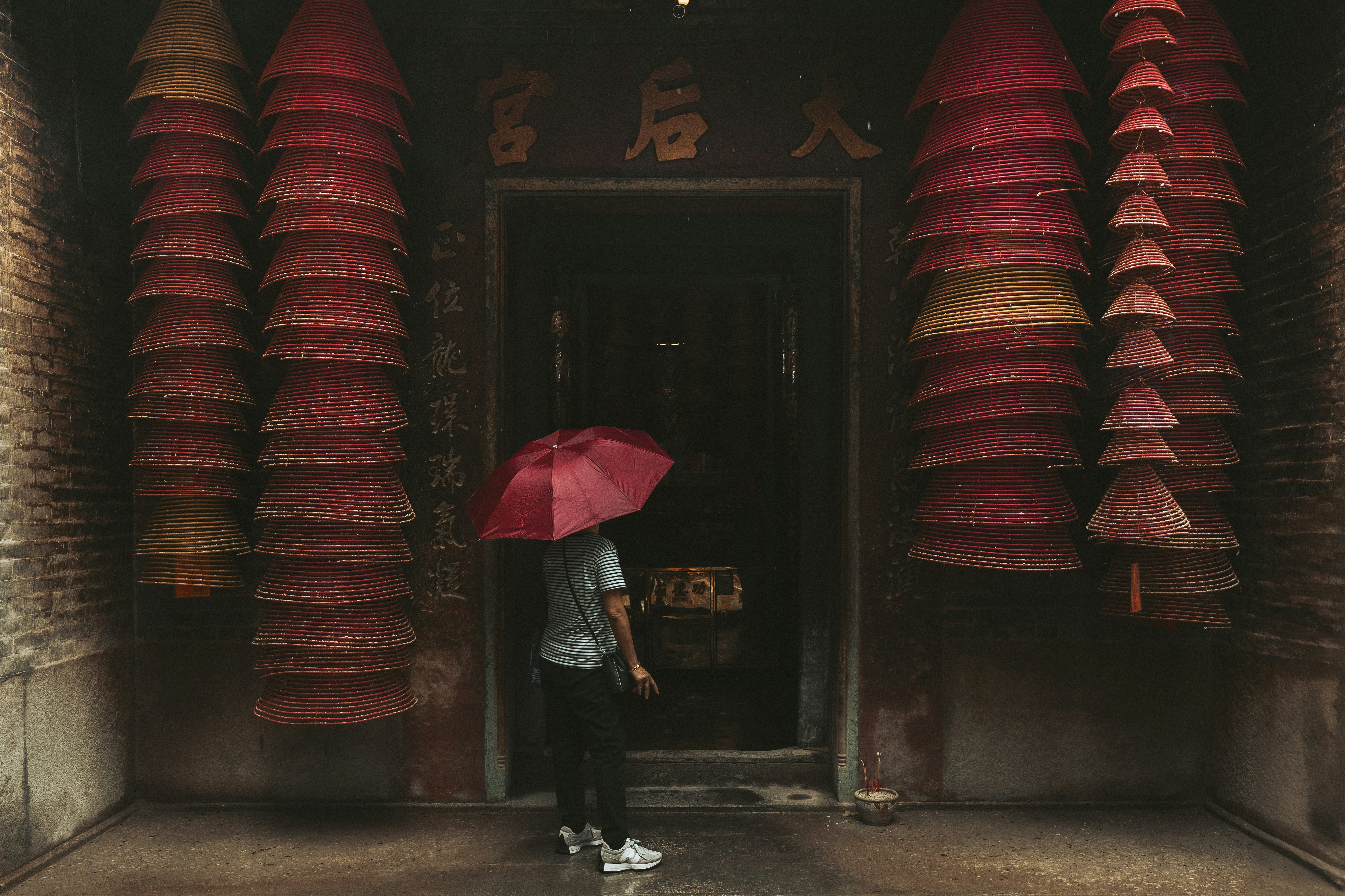Red Umbrella at the Threshold of Lanterns