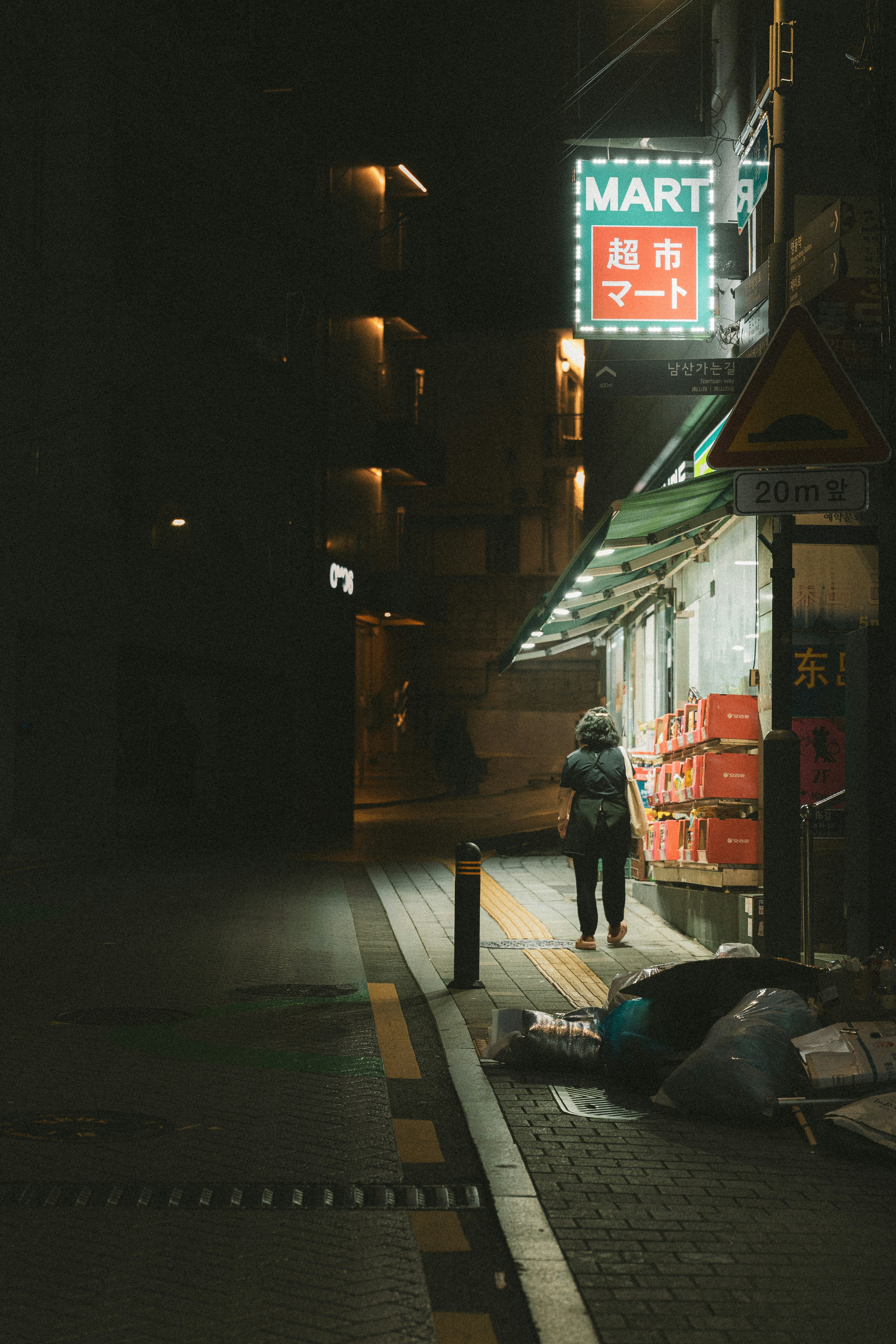 Neon Market Portrait: A Quiet Night Walk Past the Stacked Goods