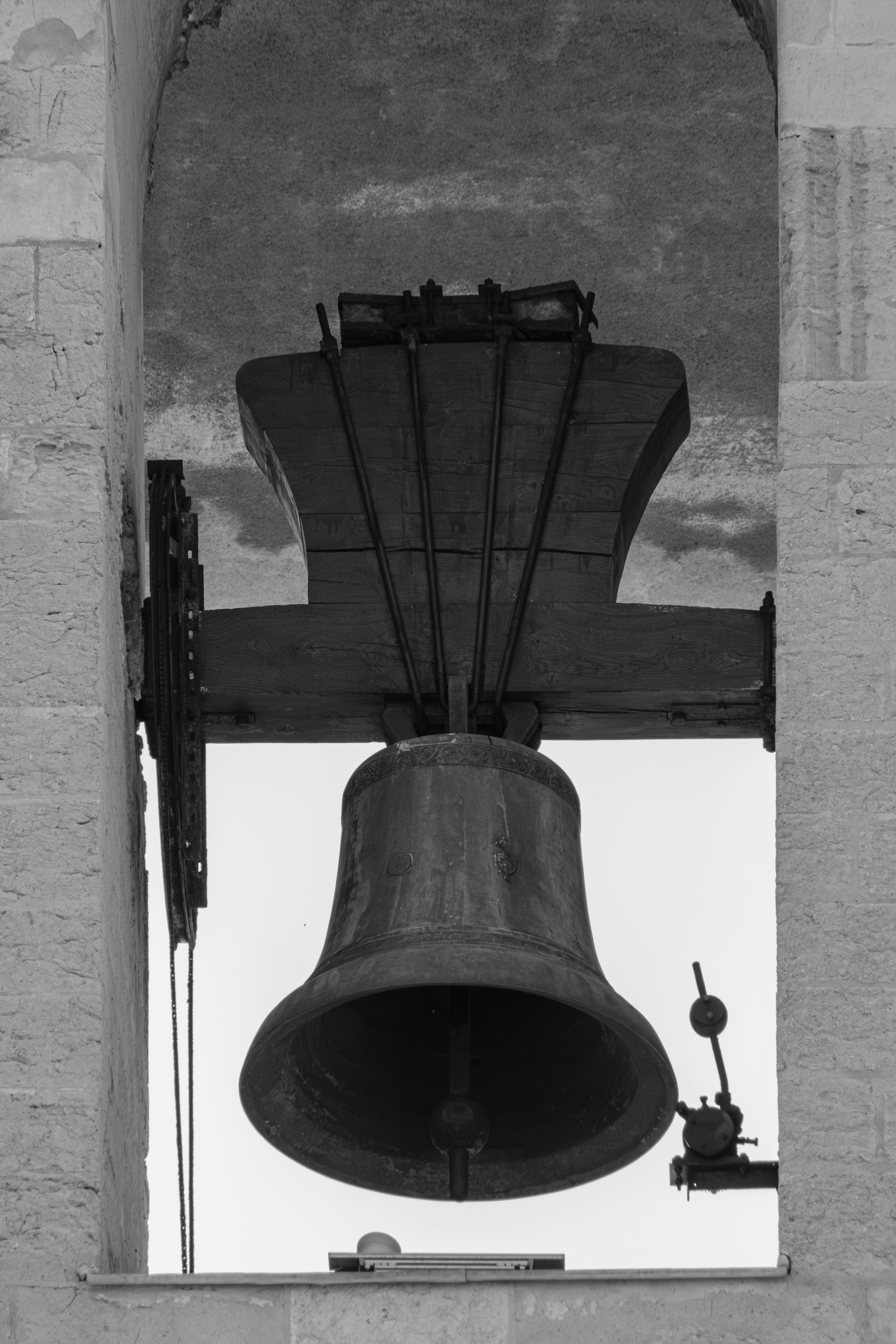 Ancient Bell Frame: A Weathered Echo in Stone