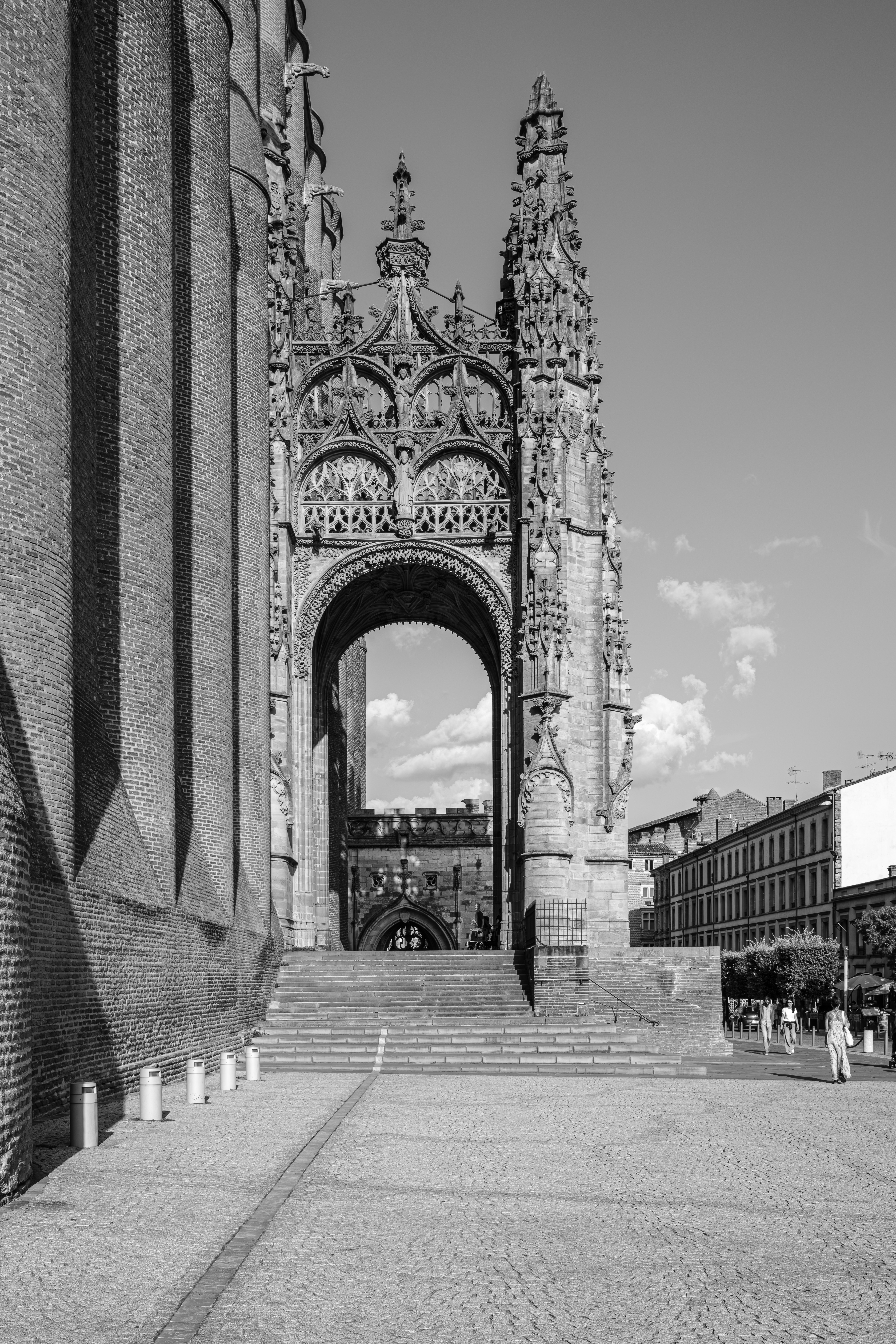 Gothic Archway Looms Over a Cobblestone Street