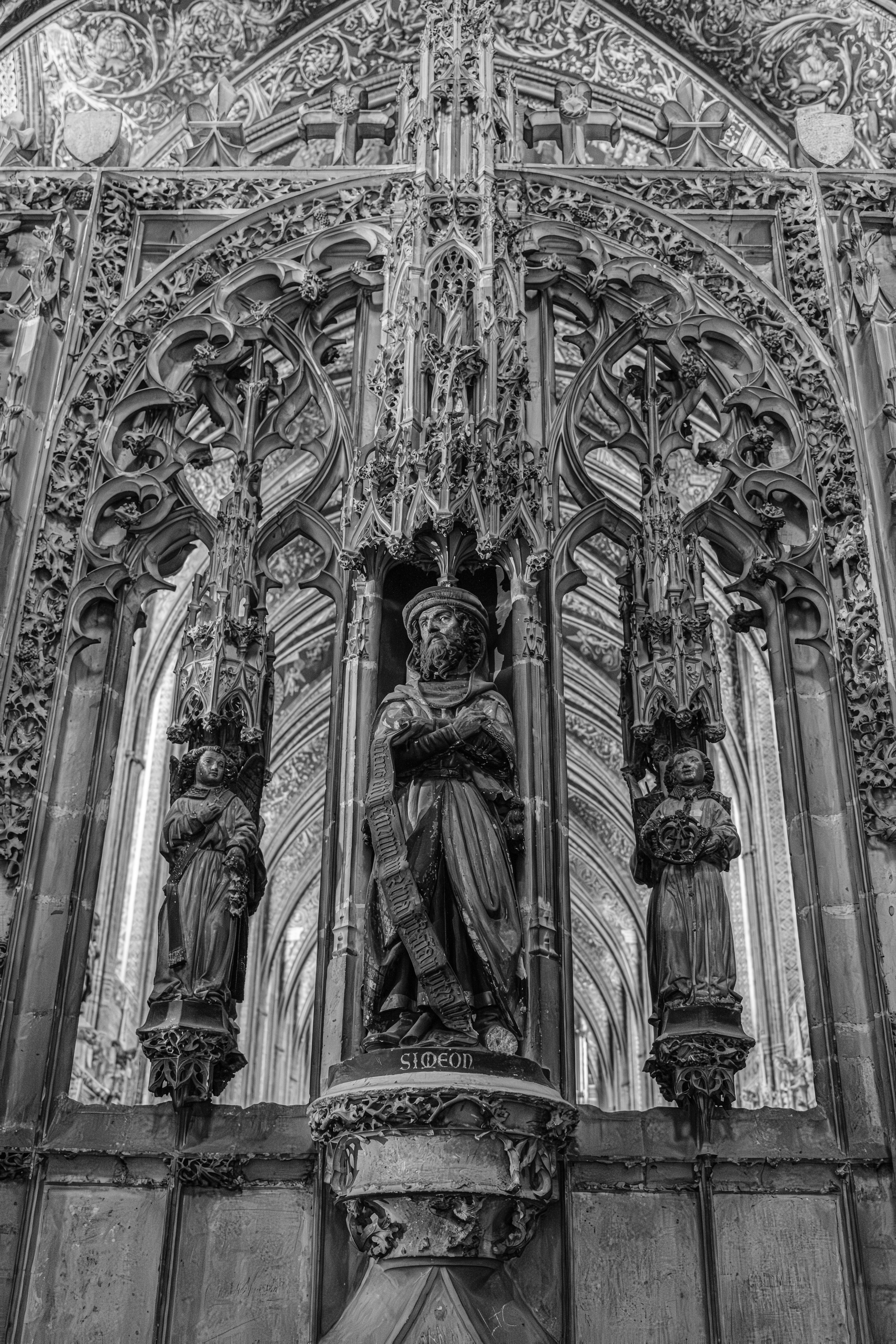 Gothic Cathedral Relief: A Central Statue Framed by Ornate Carvings