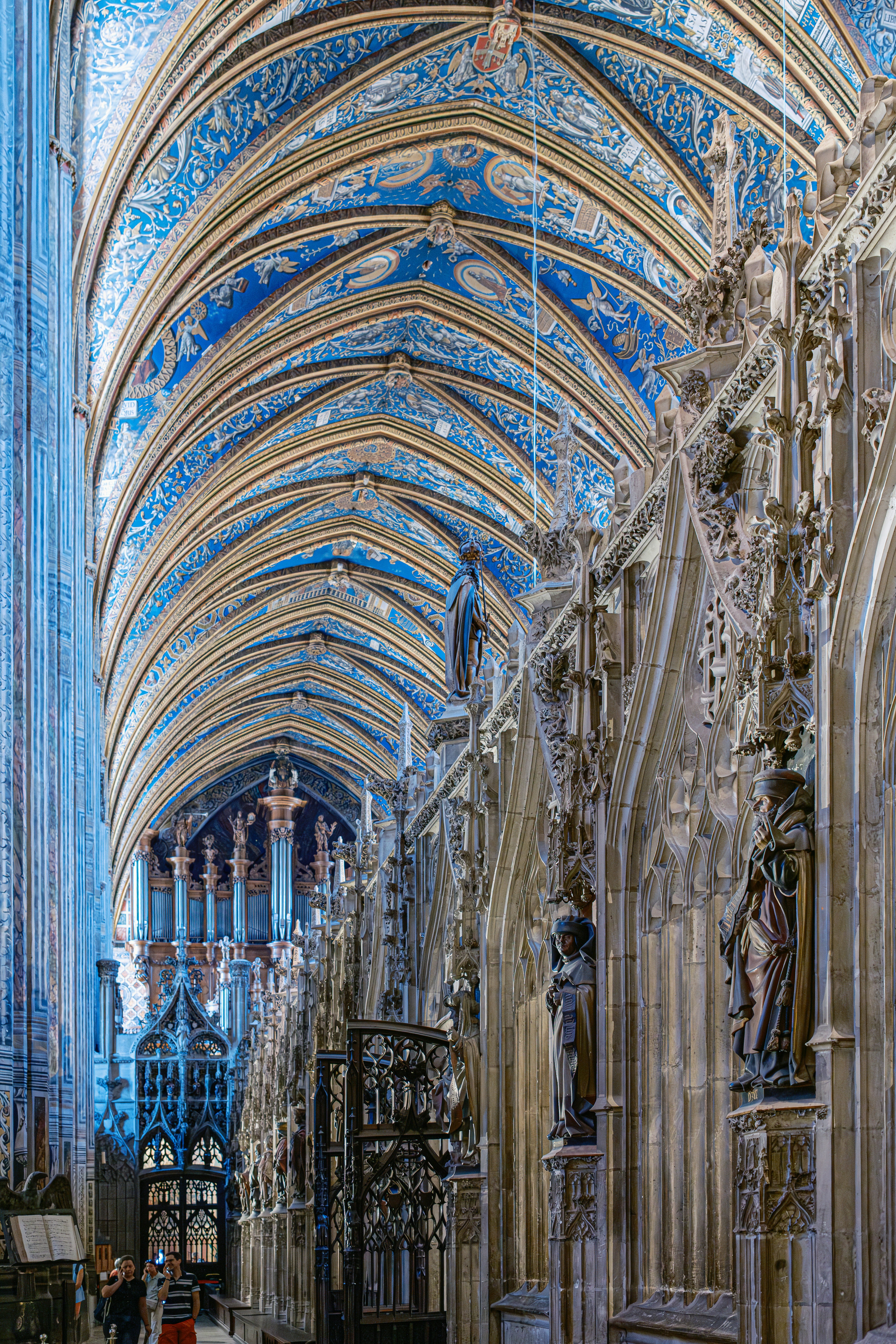Blue Vaults and Ornate Columns: A Gothic Cathedral Corridor