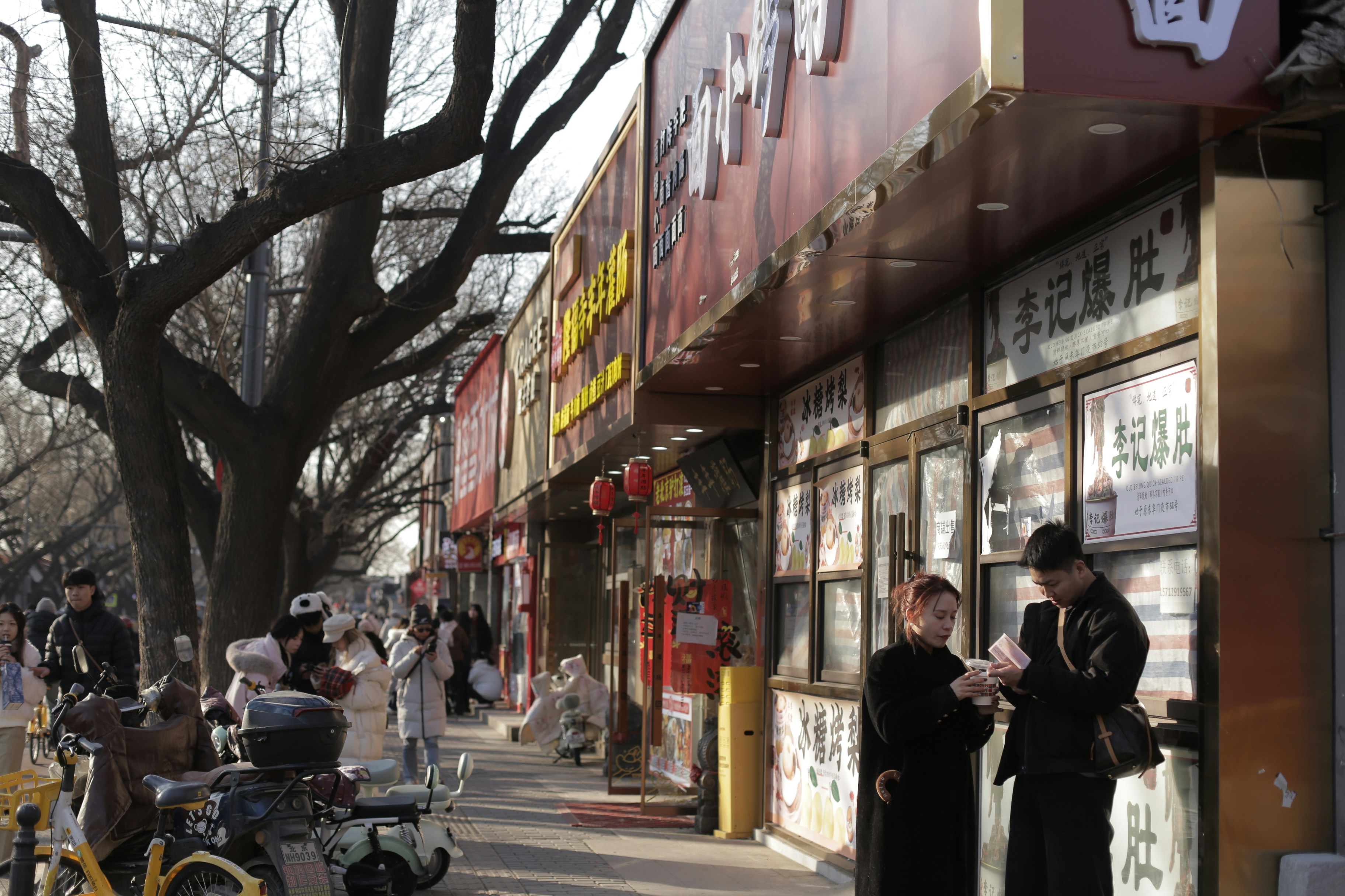 Street Trade and Conversation by a Sunlit storefront