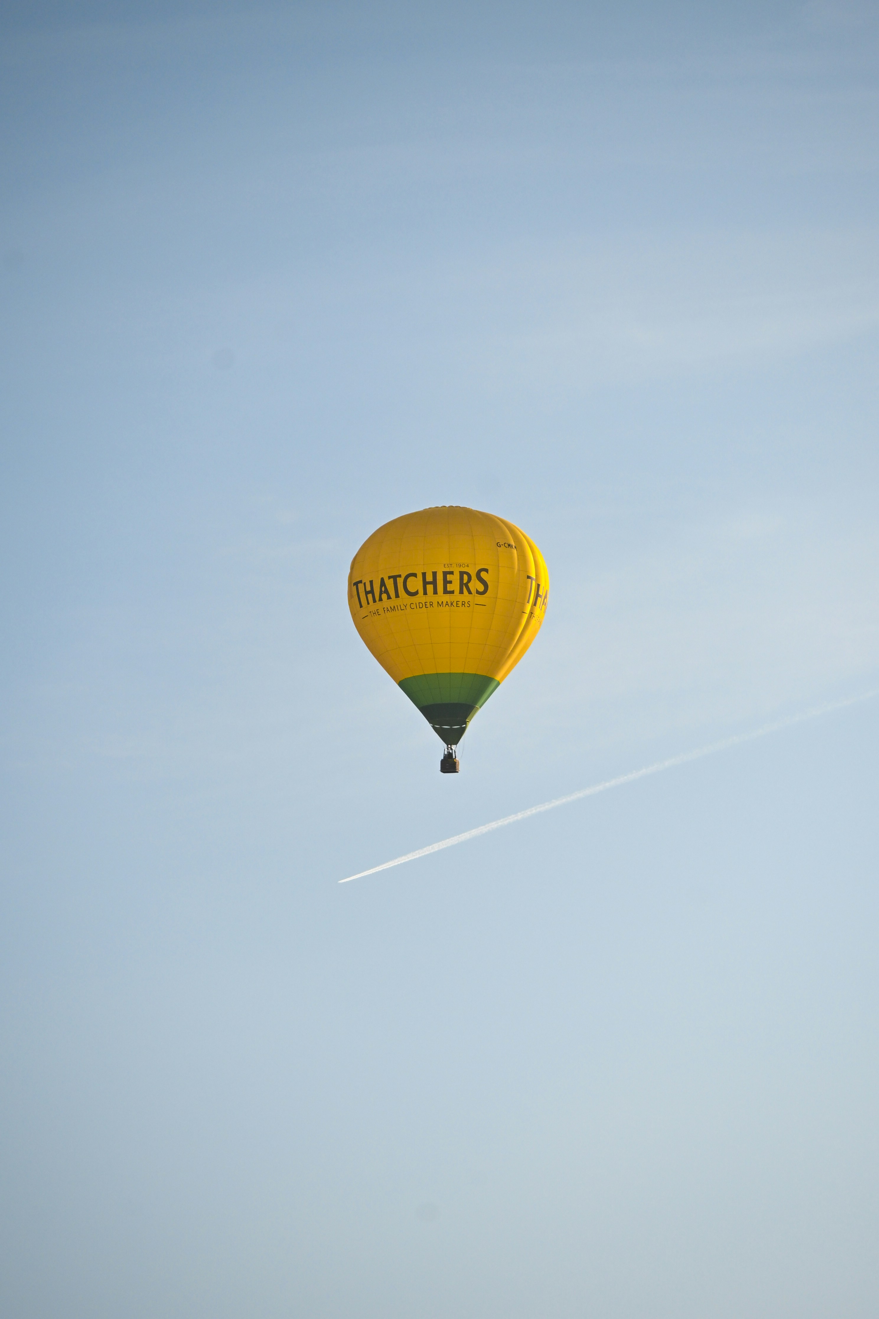 Yellow Hot Air Balloon Adrift in Clear Sky