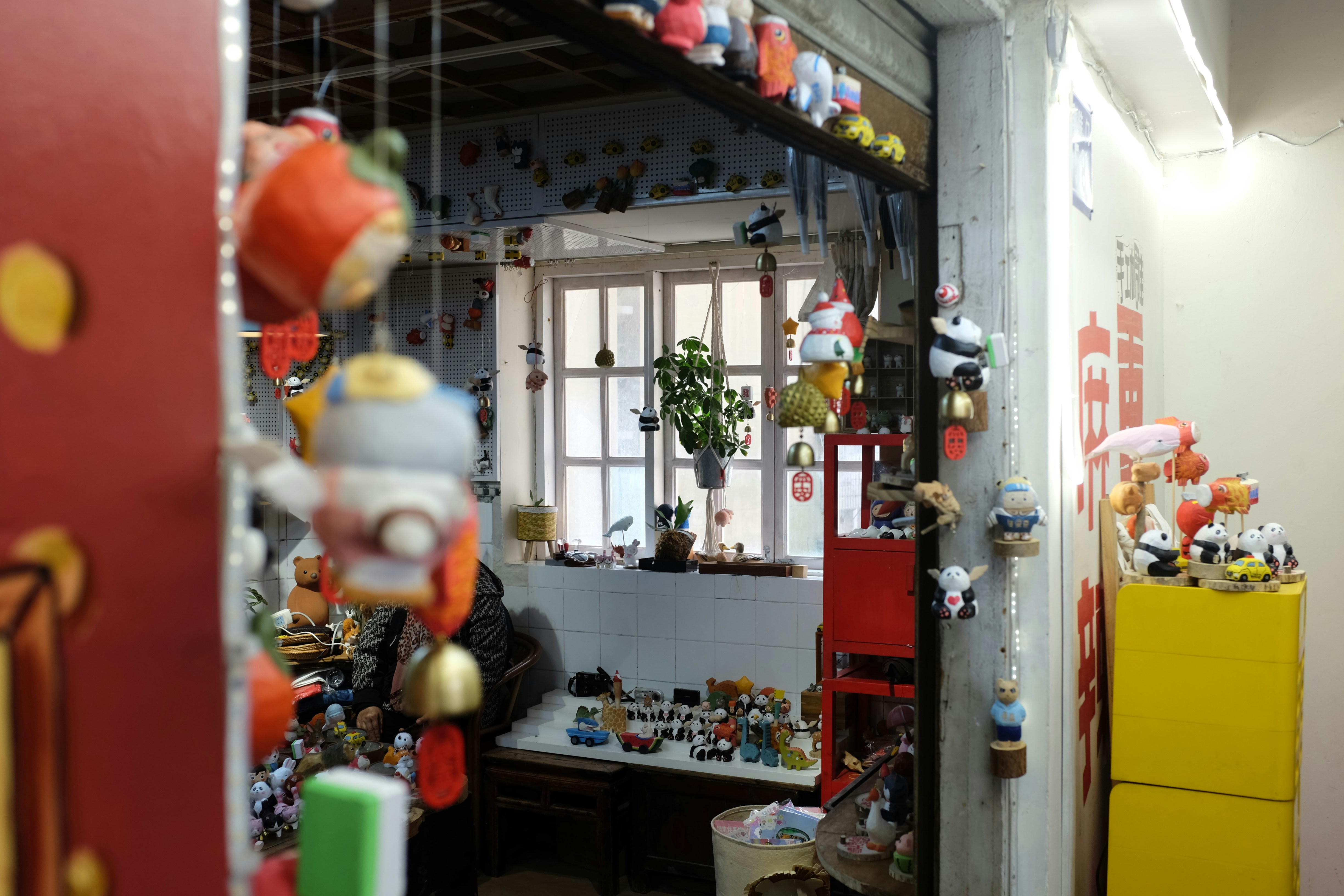 Toy-filled doorway to a cozy window-filled workshop