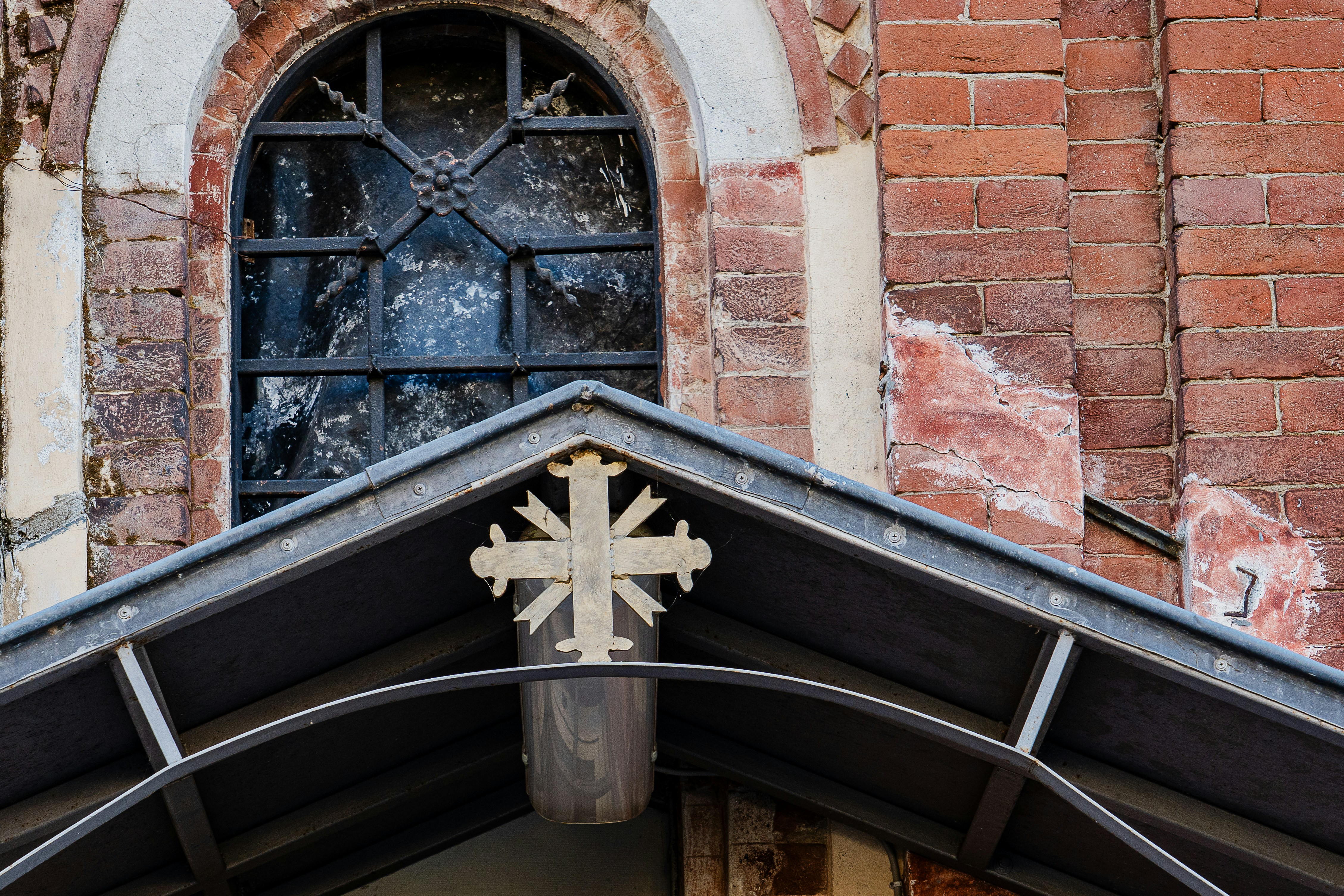 Stone Church Gable with Iron Grille Window and Cross Detail