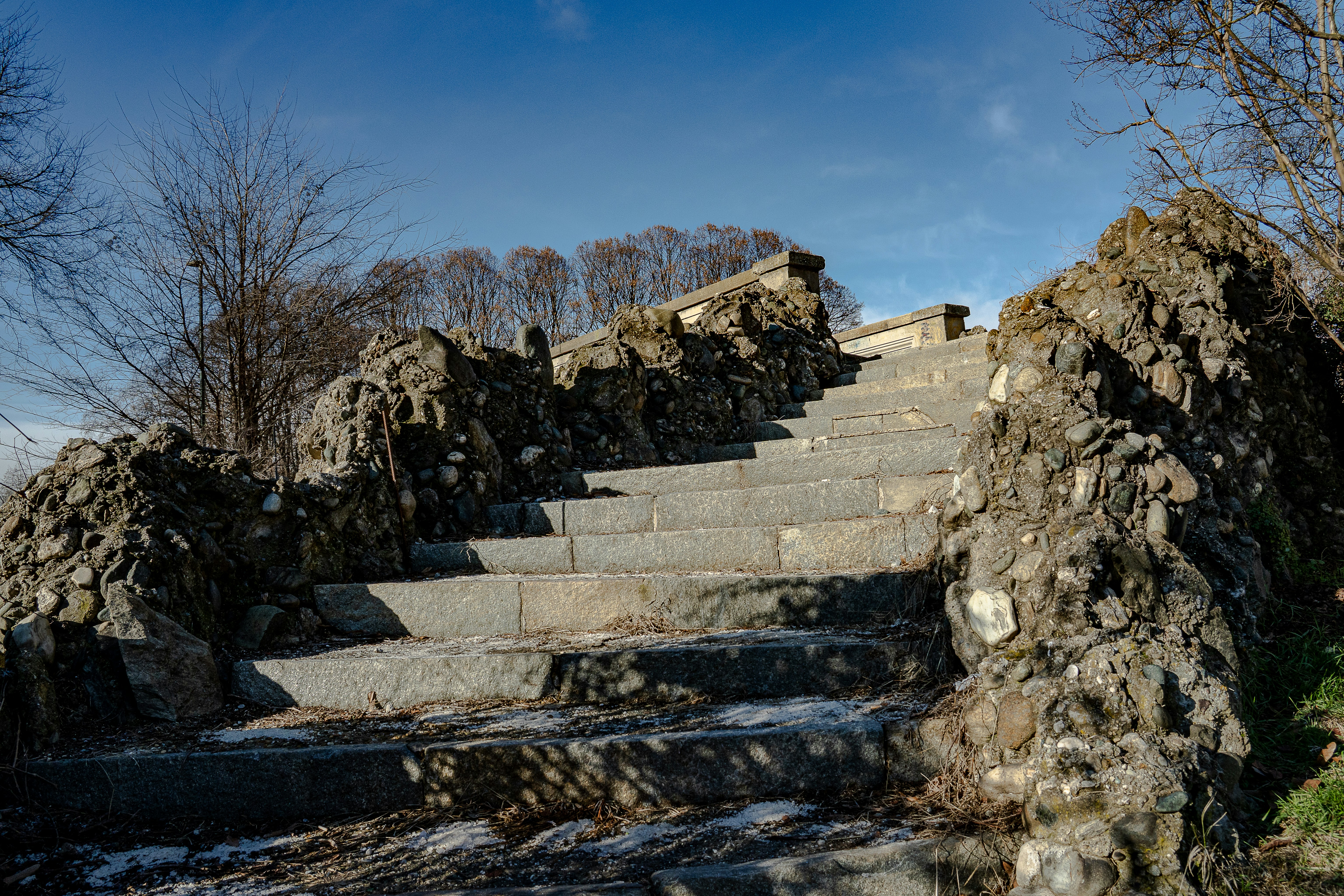 Stairway Through Weathered Ridge: Cracked Stone Steps Toward a Blue Day
