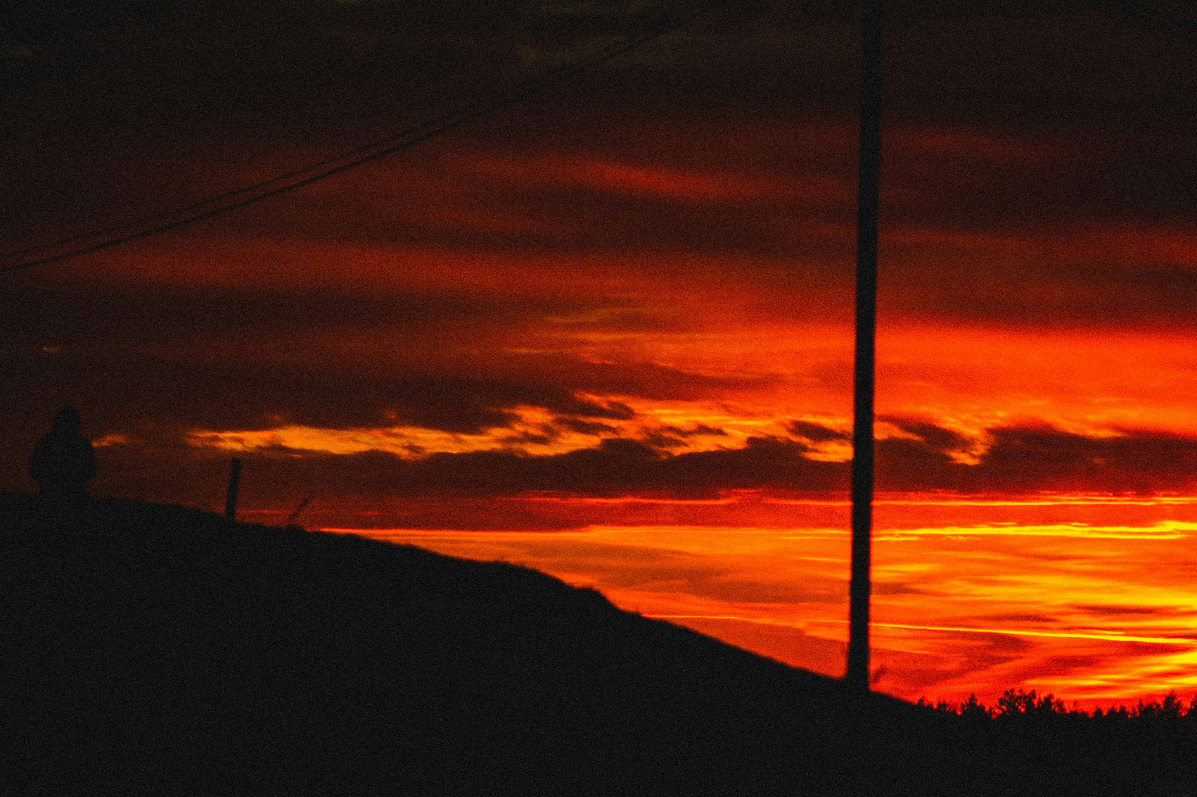 Crimson Horizon Over the Silhouetted Ridge