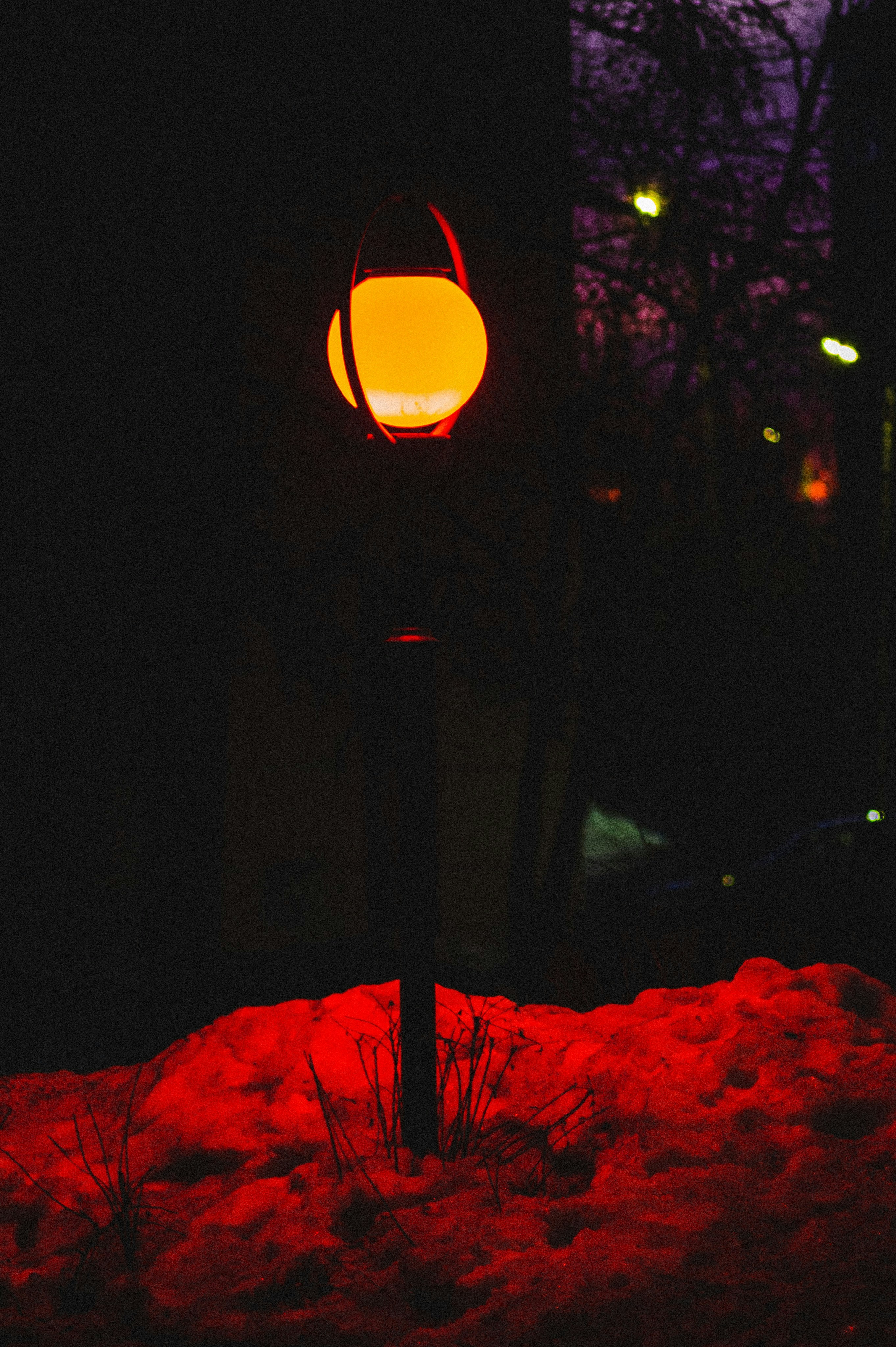 Glowing Lamp Post Piercing the Night Snow