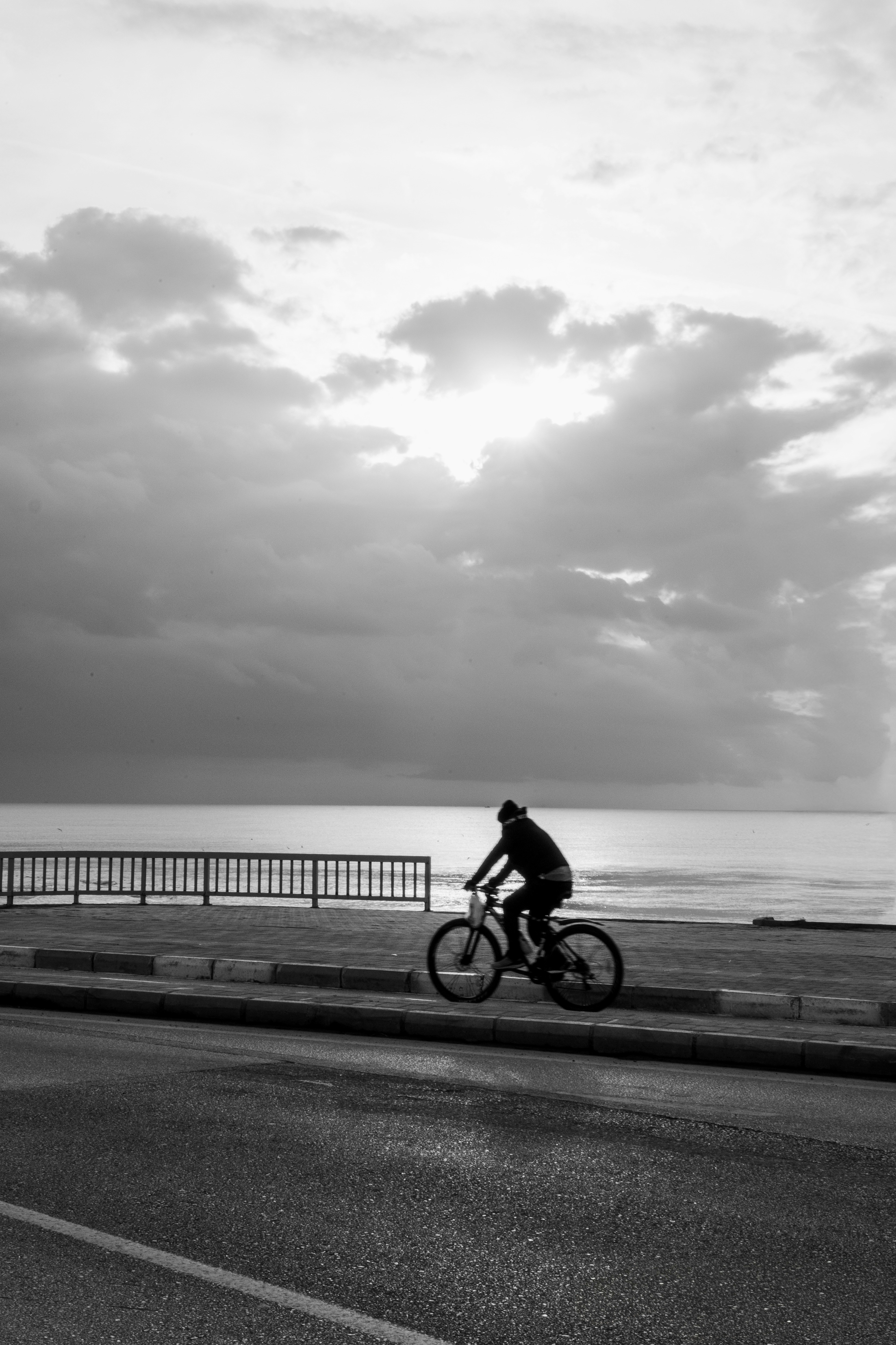 Midday Rider Along a Quiet Coastal Road