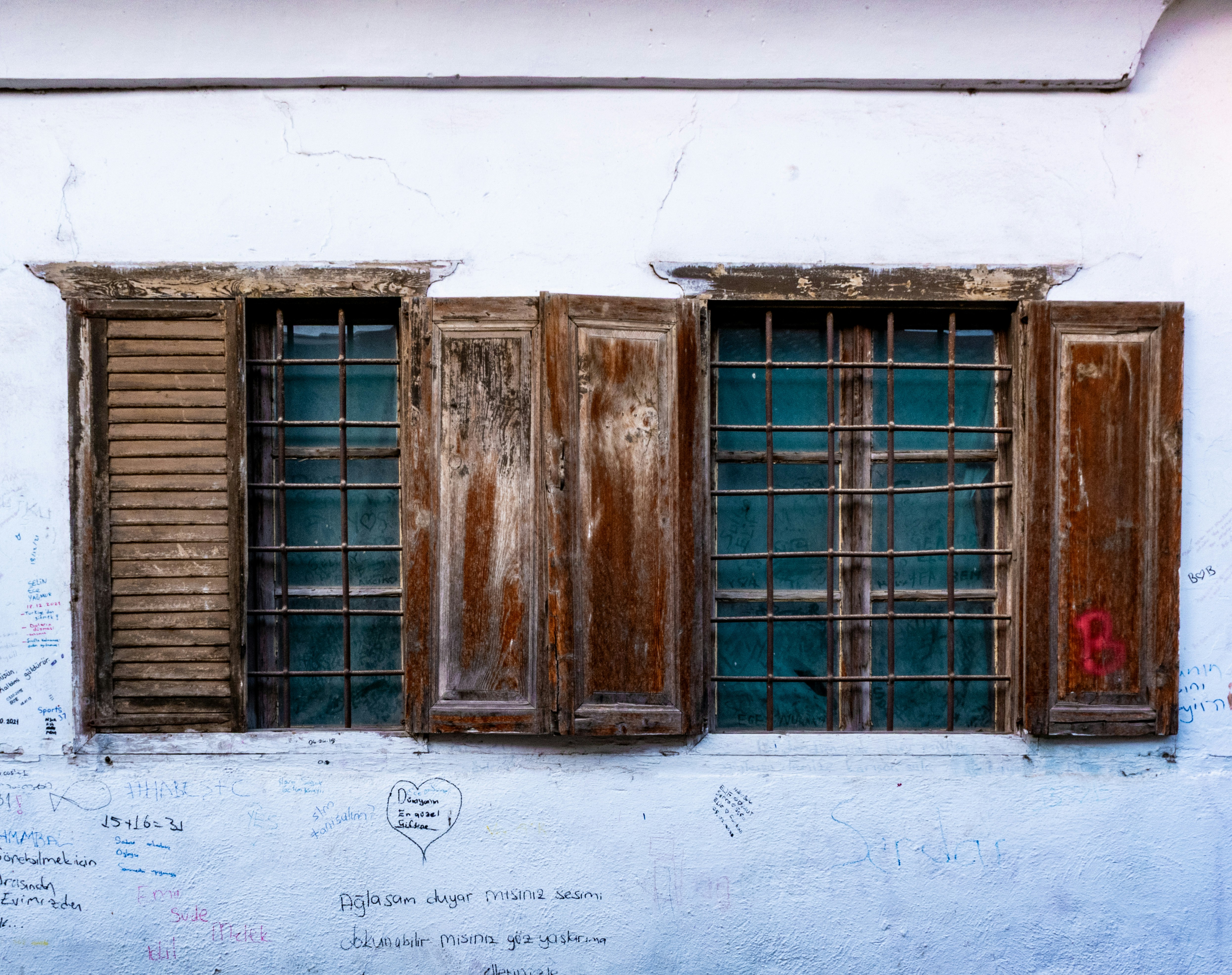 Weathered Window Quartet on a White Facade