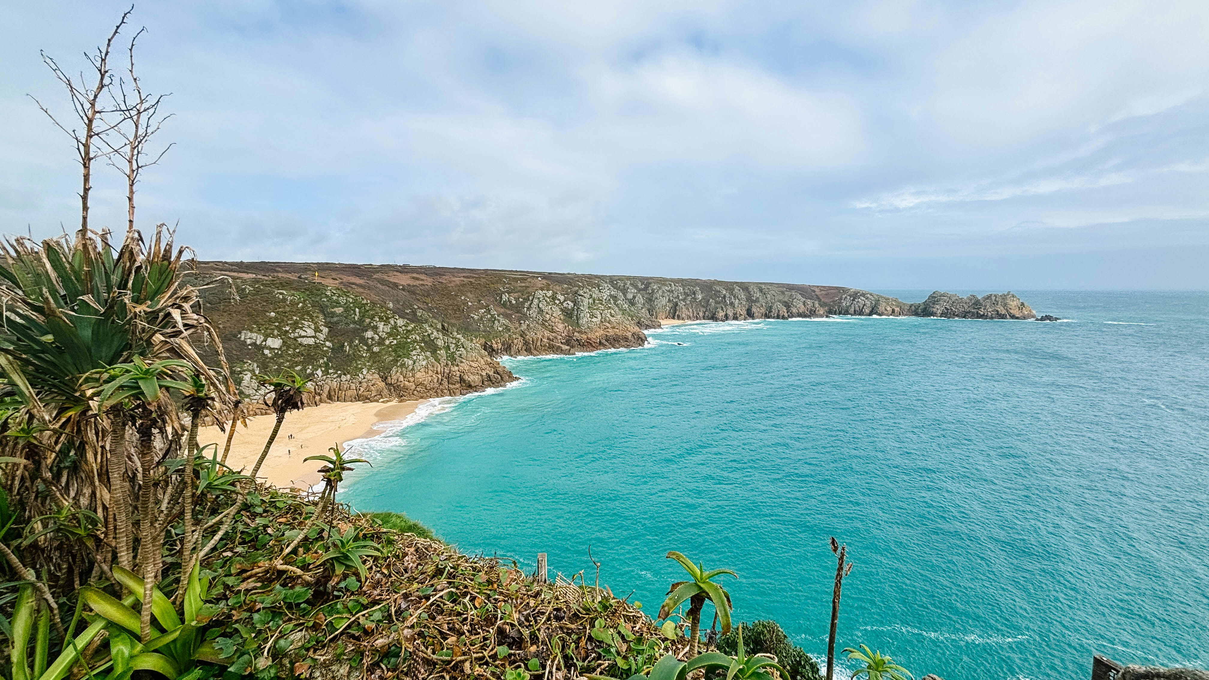 Cliffside Cove: Turquoise Sea Meeting Golden Shore