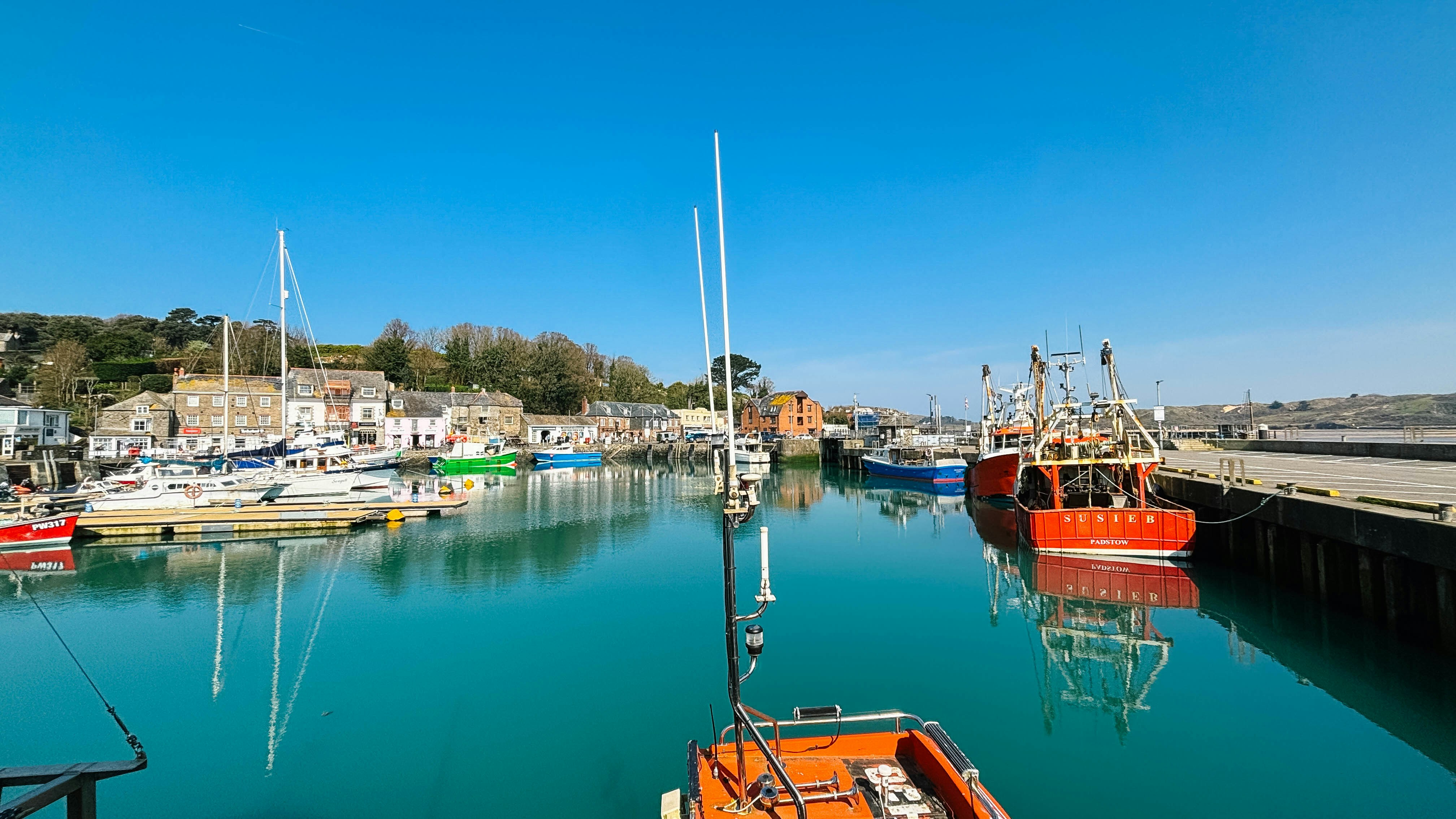 Harbor Morning: A Quiet Lineup of Boats Reflecting on Turquoise Waters
