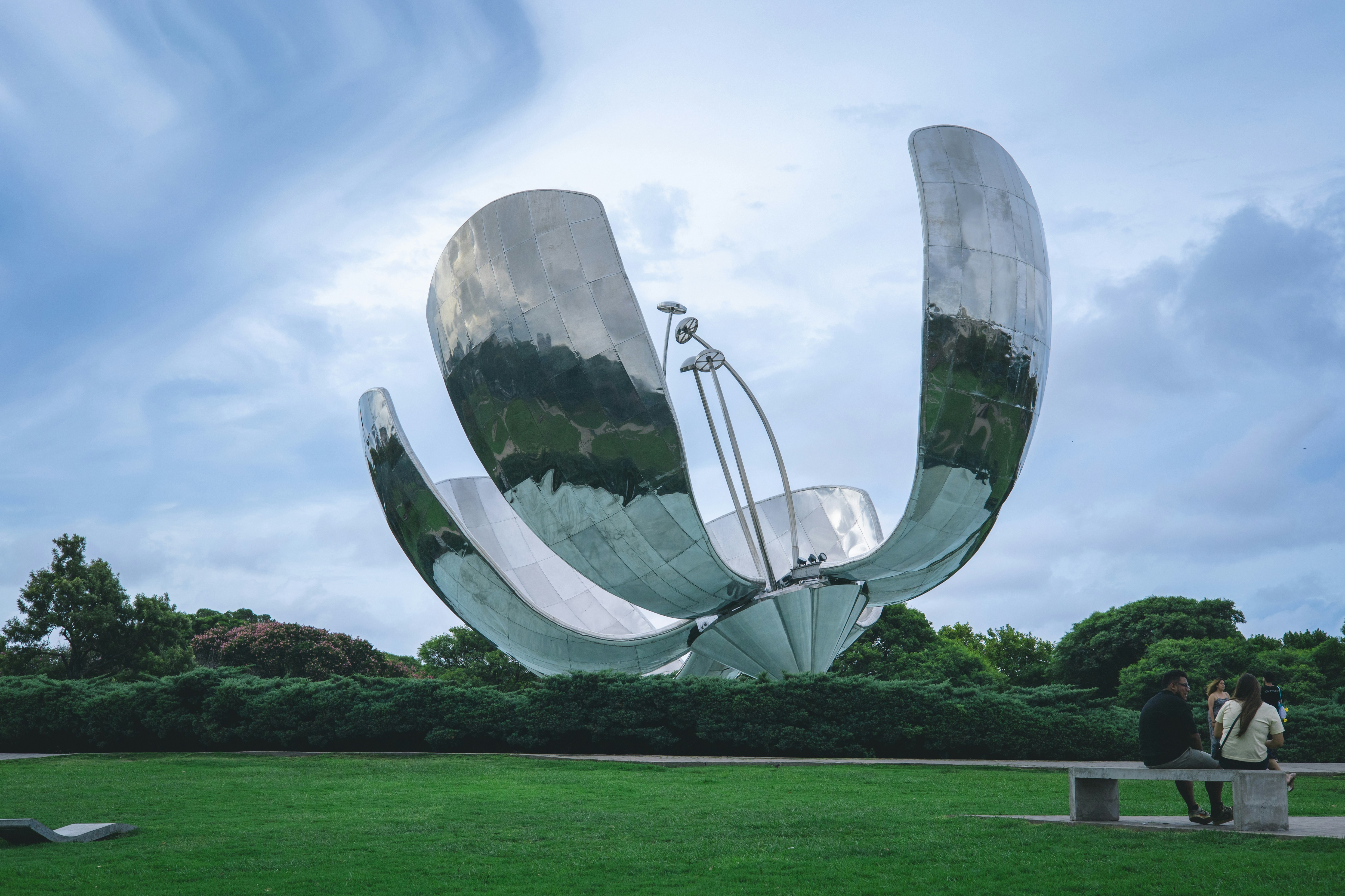 Chromed Petals: The Reflective Sculptural Bloom Against a Quiet Park