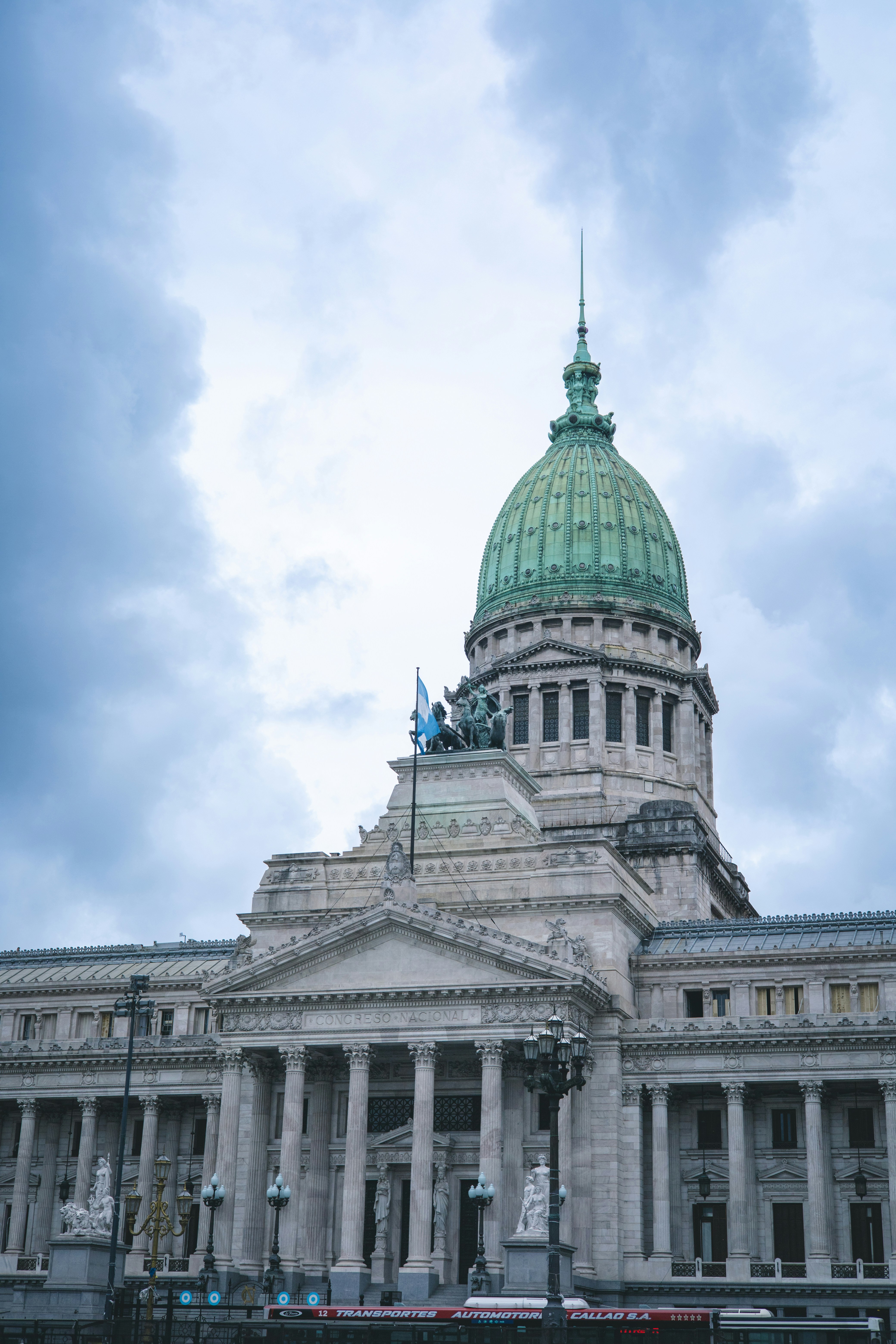 The Green Dome guard: a grand capitol silhouette against a cloudy sky