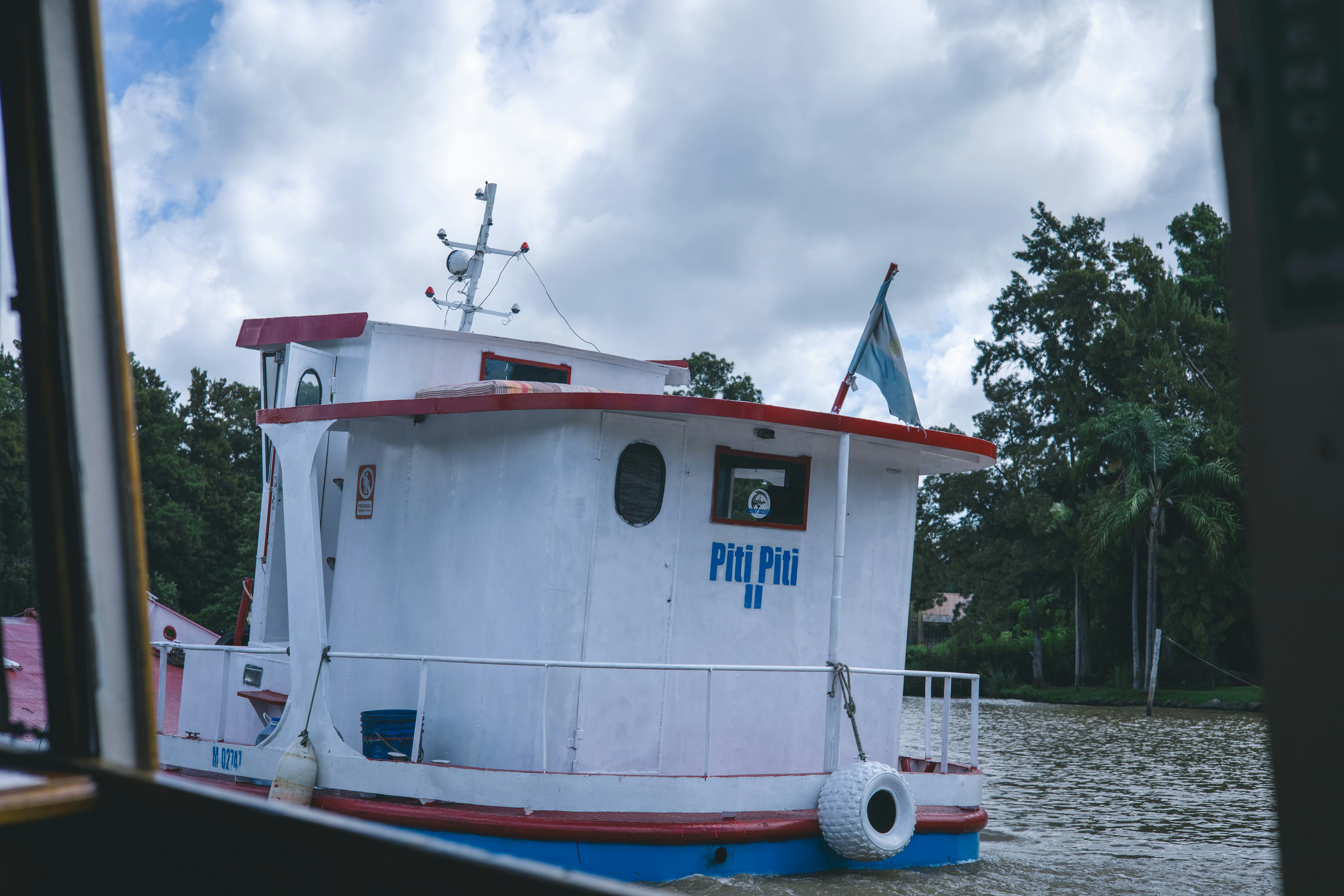 Boat House on Calm Water: Piti Piti Floats in the Wake