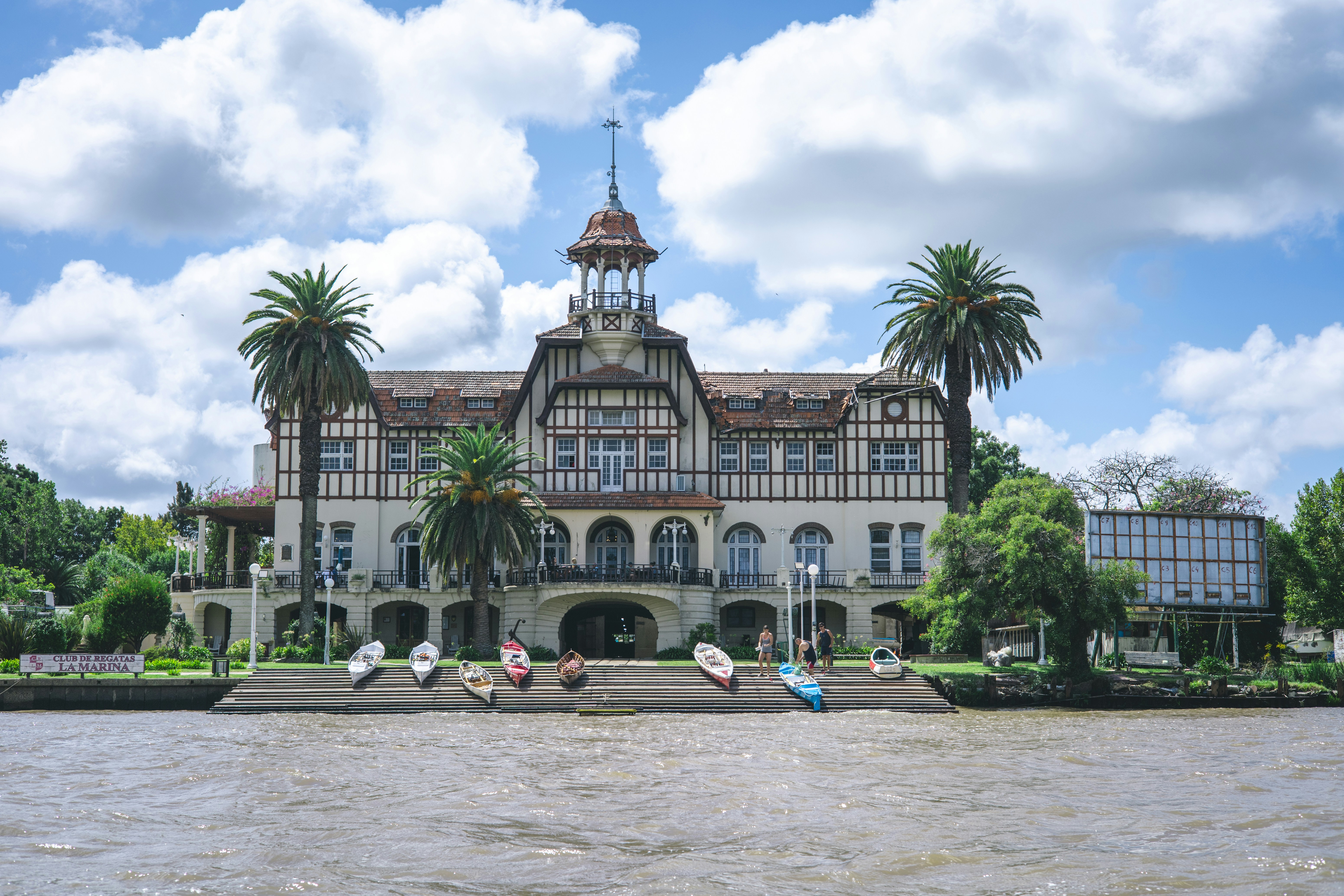 Courtyard Crest: A Venetian-Style Town Hall Pier and Palm-Fringed Waterfront