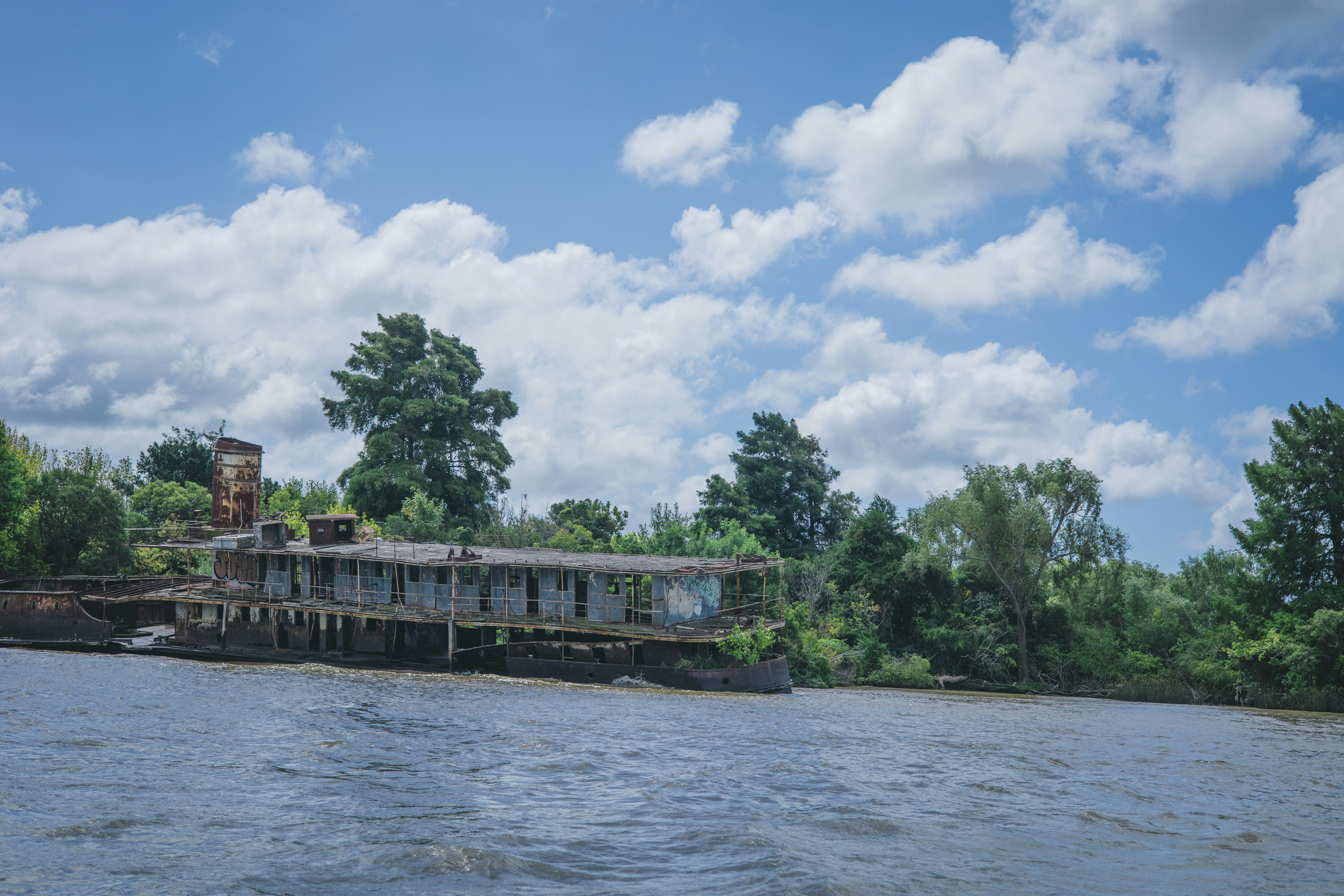 Rusted Afloat: A Decaying Platform Lingers Along a Quiet Riverside