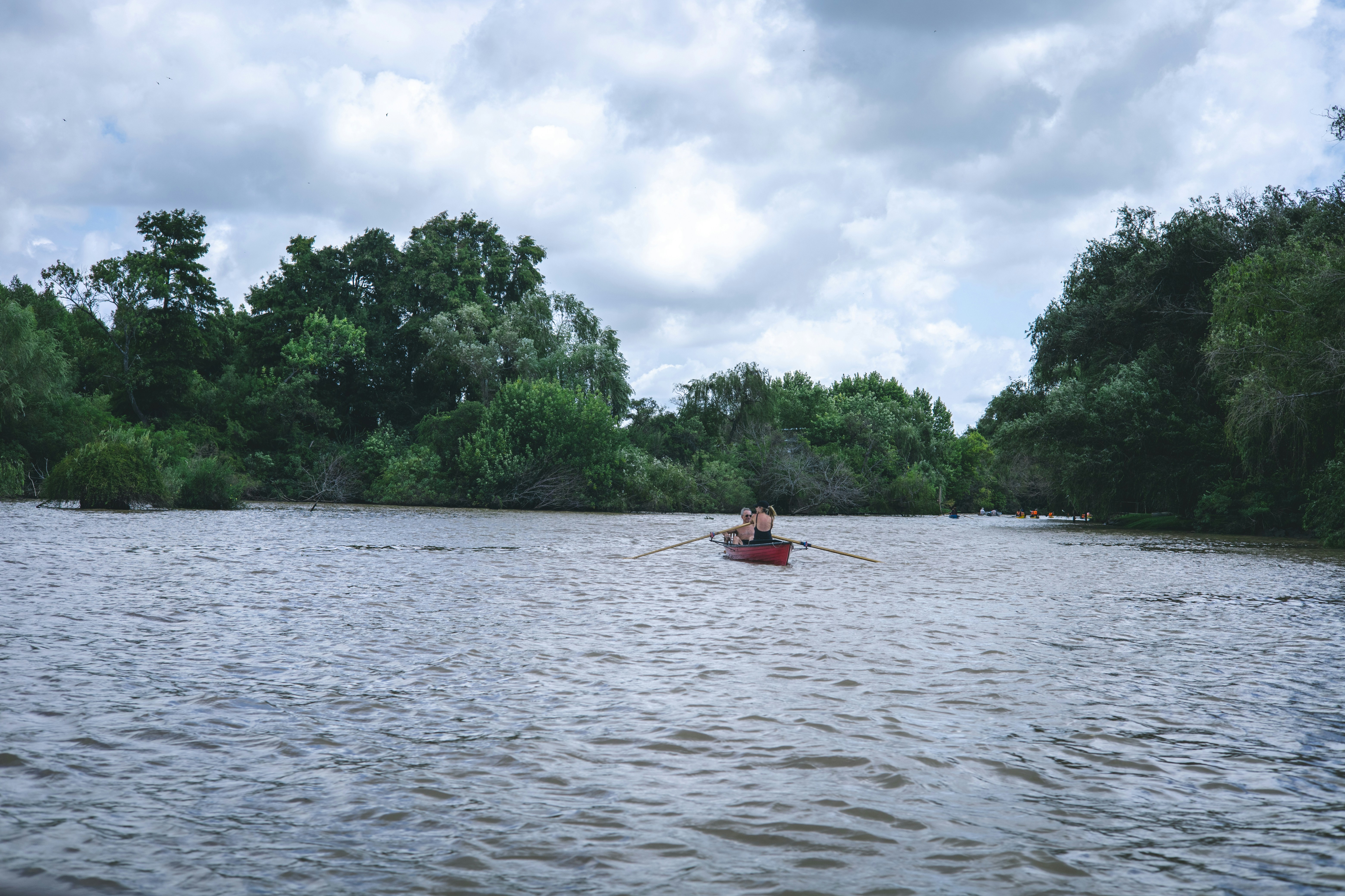 Riverside Canoe: A Lone Vessel Among Quiet Backwater