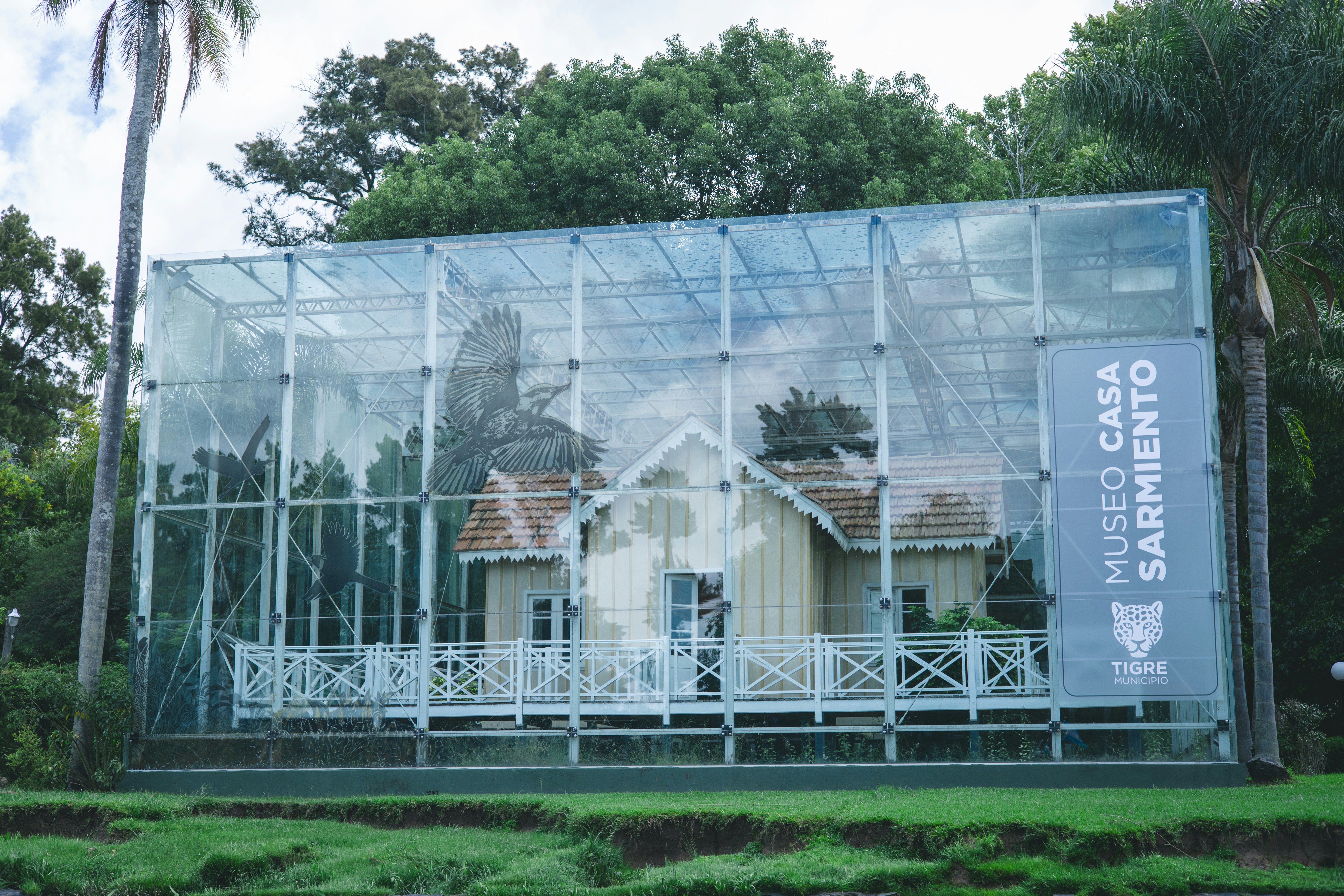 Glass-encased Toy House: A Museum Within Verdant Frames