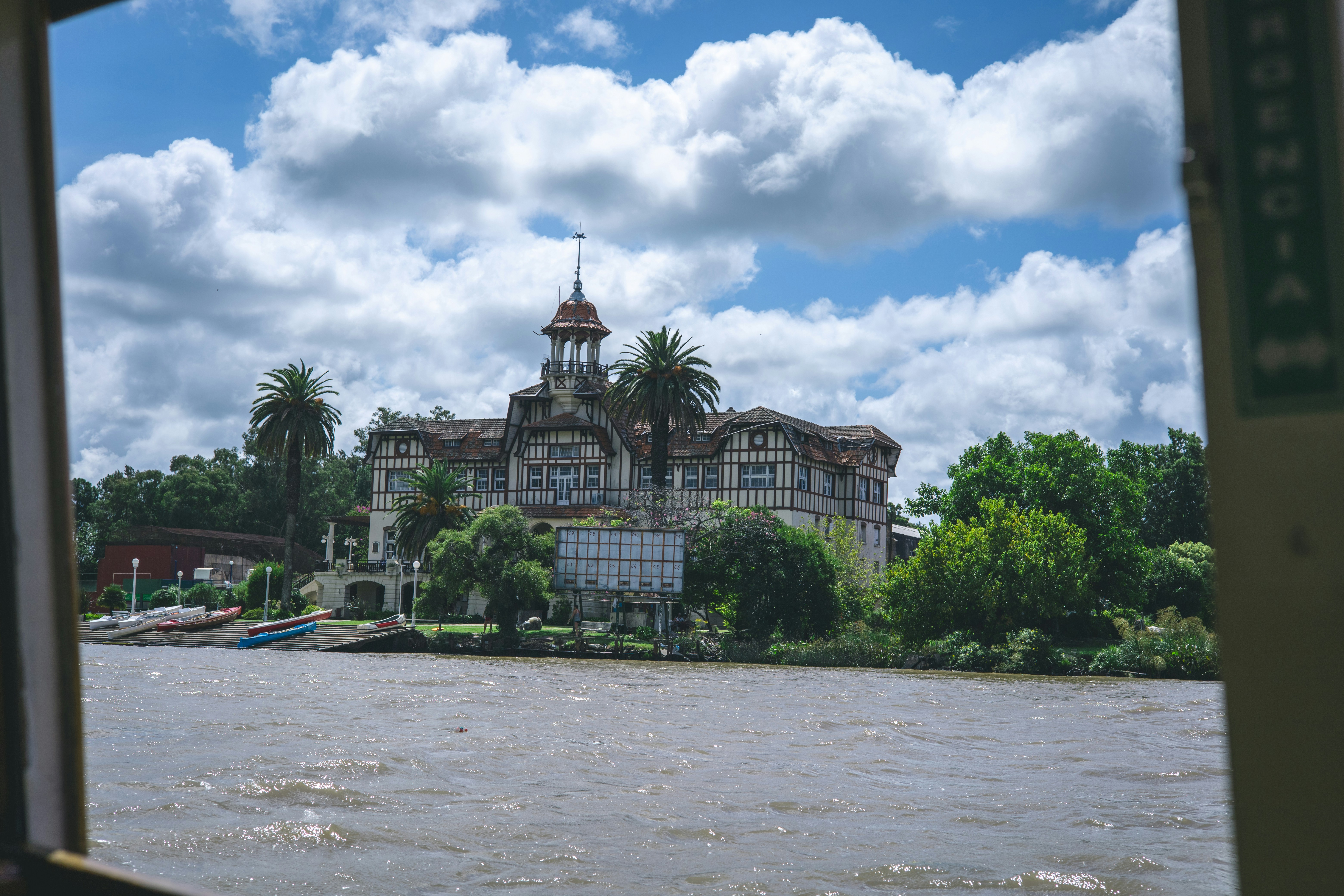 Riverside Chateau: A Historic Estate Framed by Palm Trees