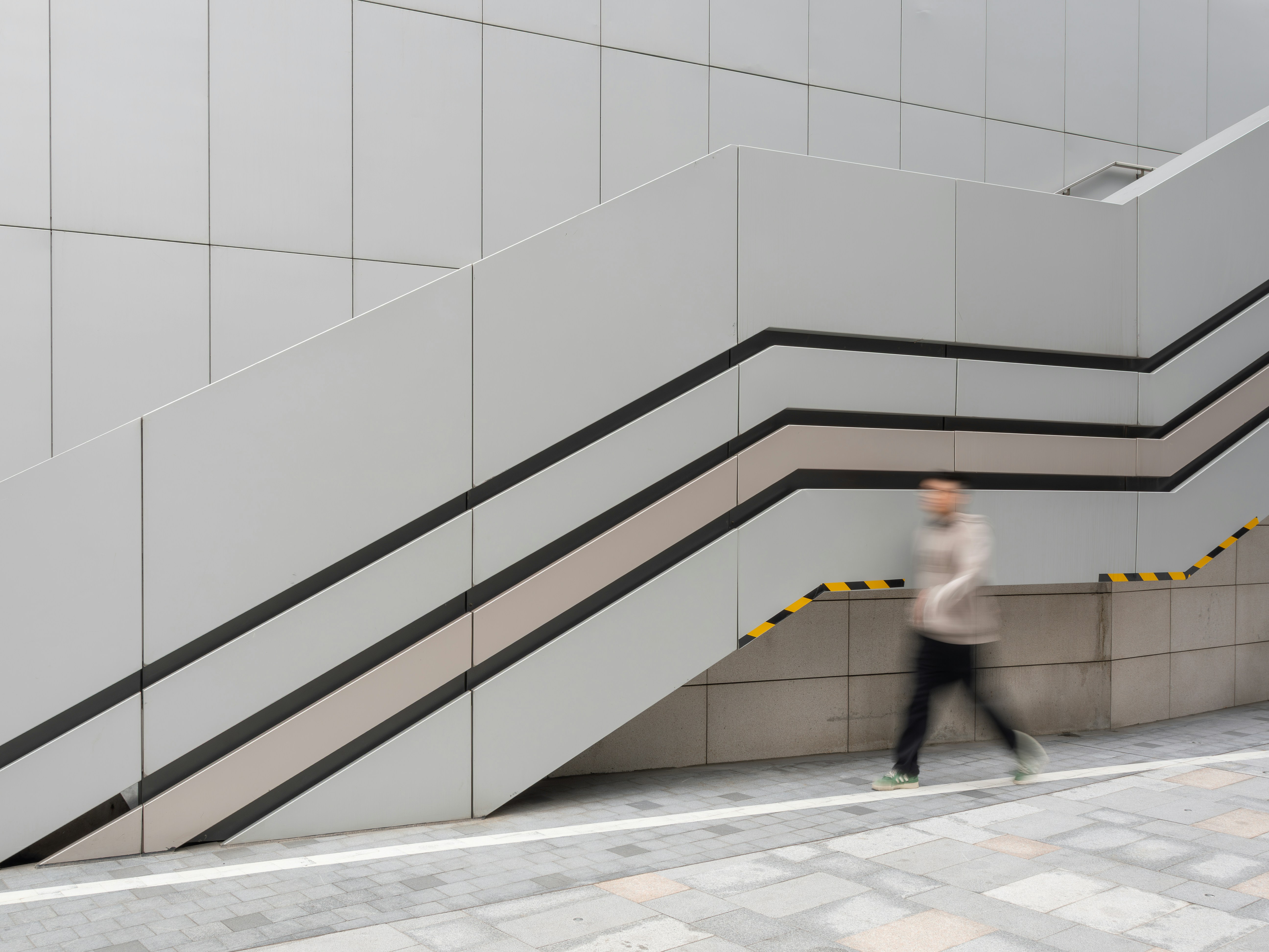 Blurred stride across a geometric stairscape