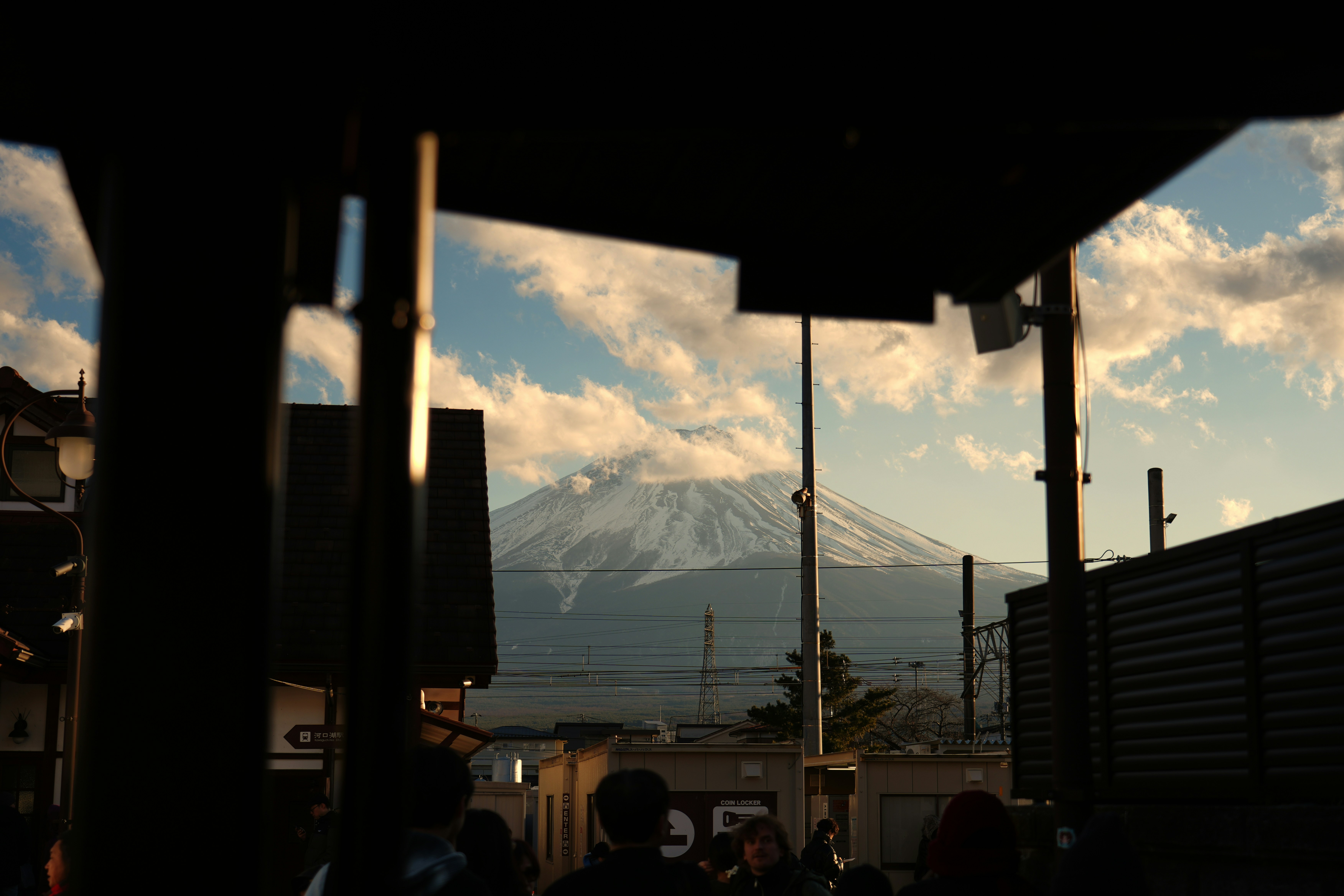 Snow-capped mountain peak against a cloudy sky.