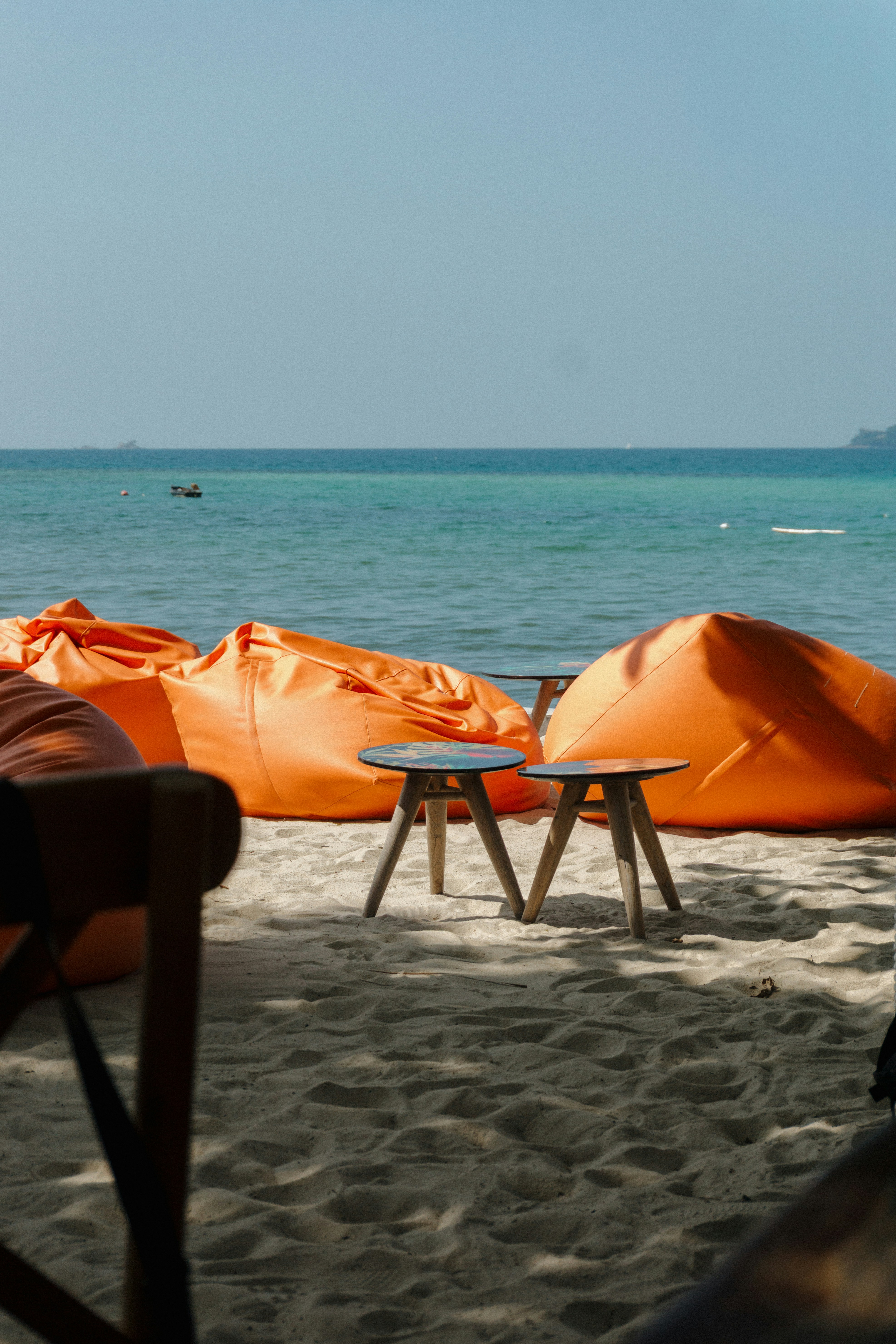 Sunlit Orange Cushions on a Quiet Beach