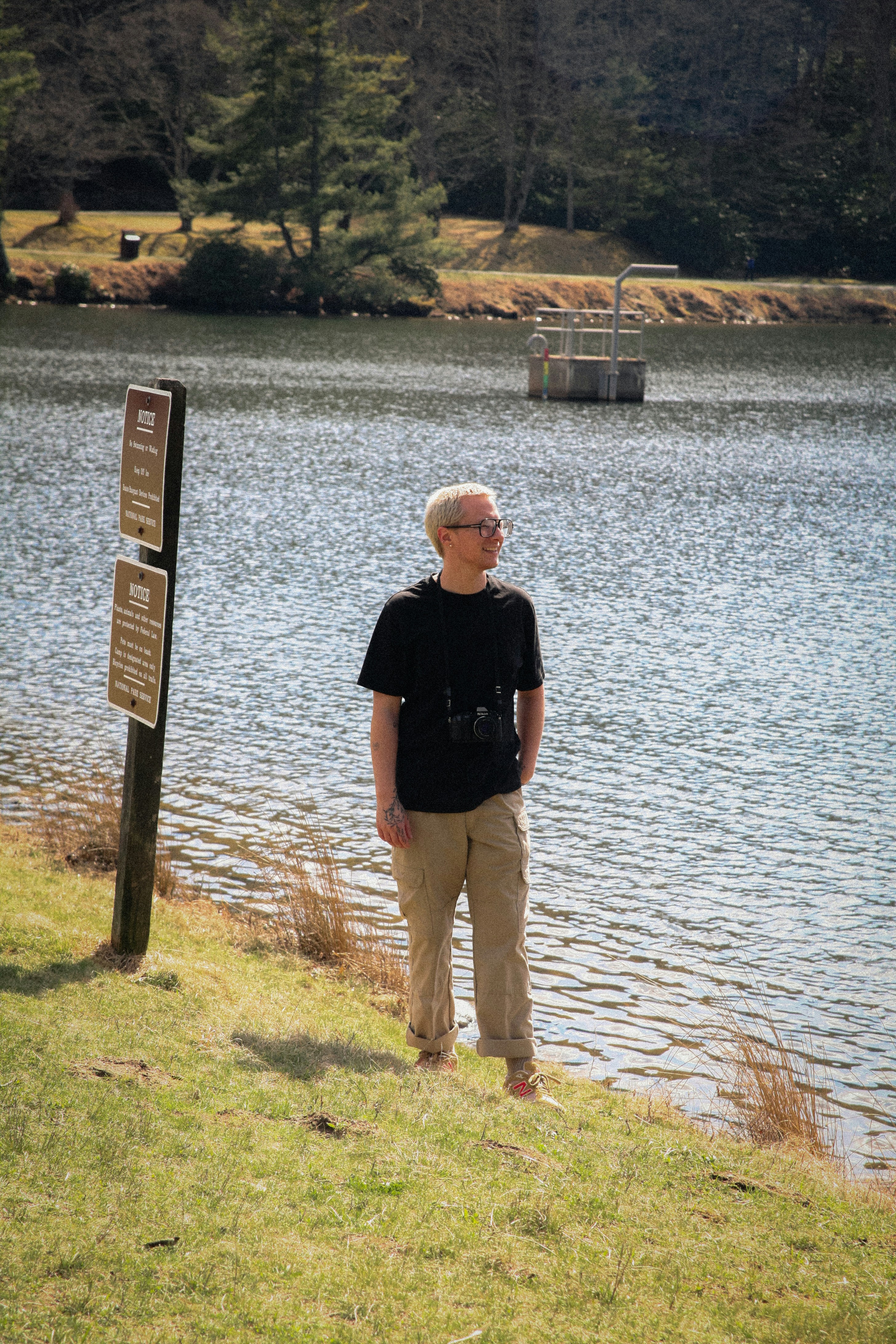 Lone Explorer by the Lake: A Quiet Moment on the Grass