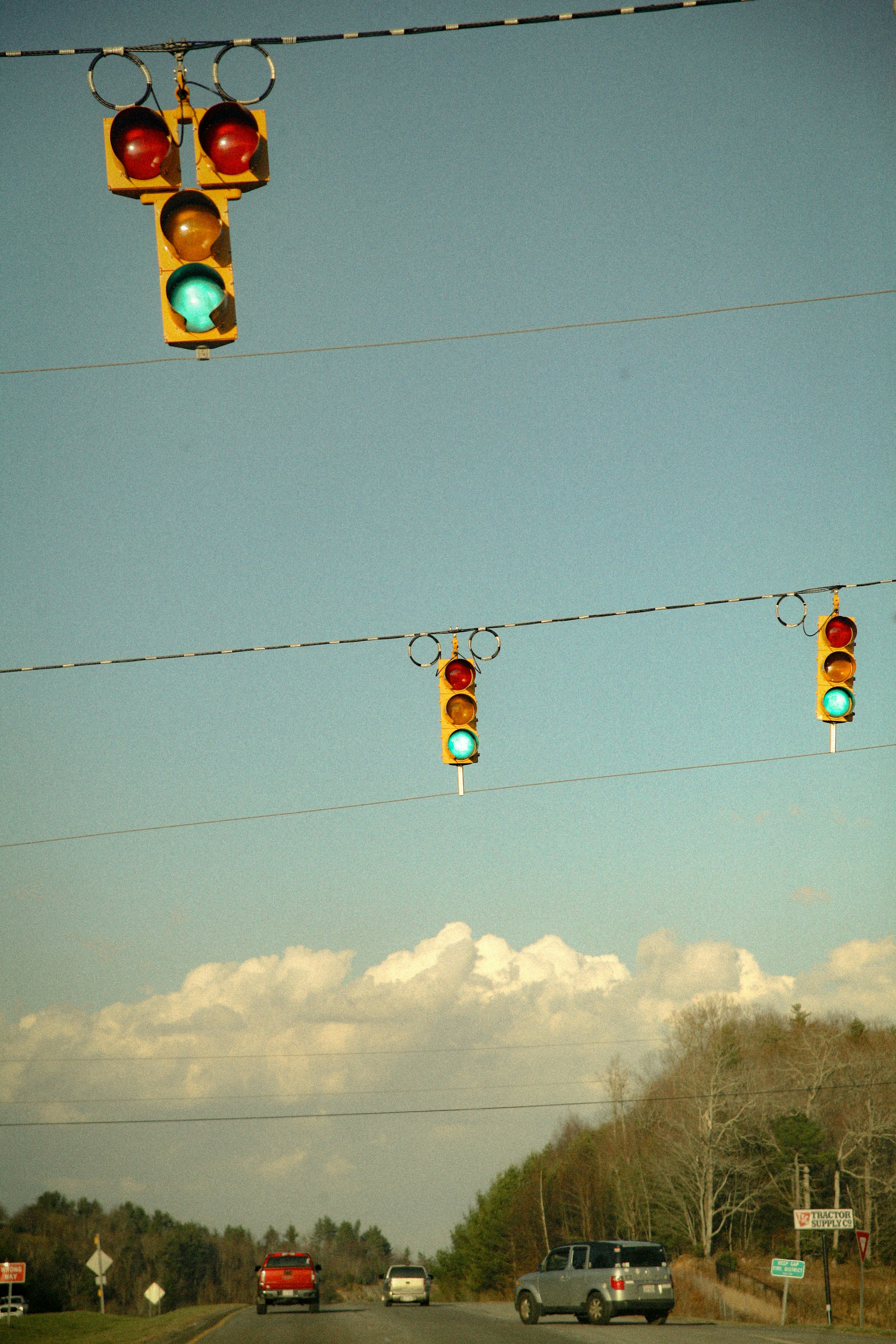 Waiting for the Signal: Empty Road Beneath a Rising Traffic Sky