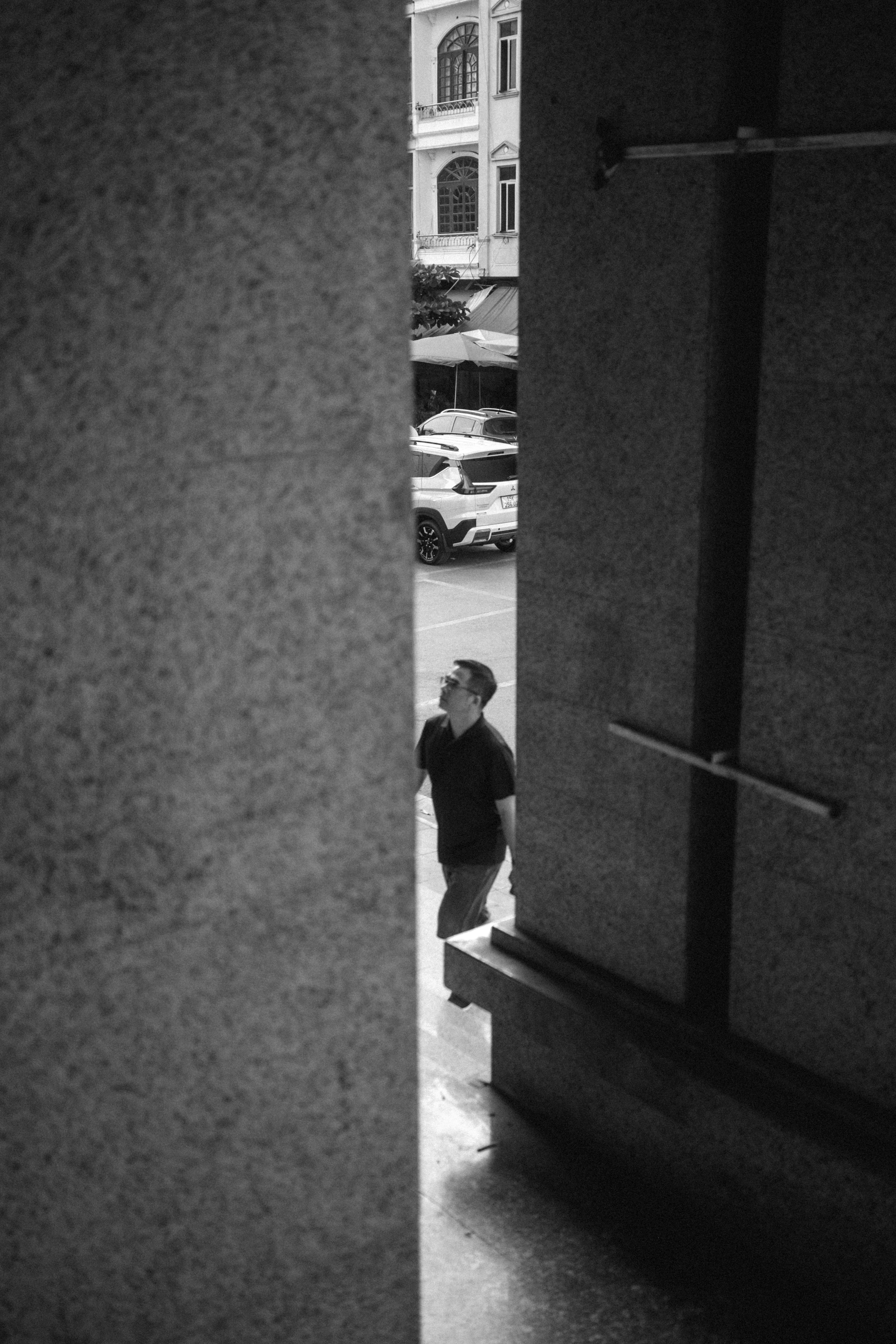 Through the Sliver: A Quiet Moment of a Stranger in the Gap