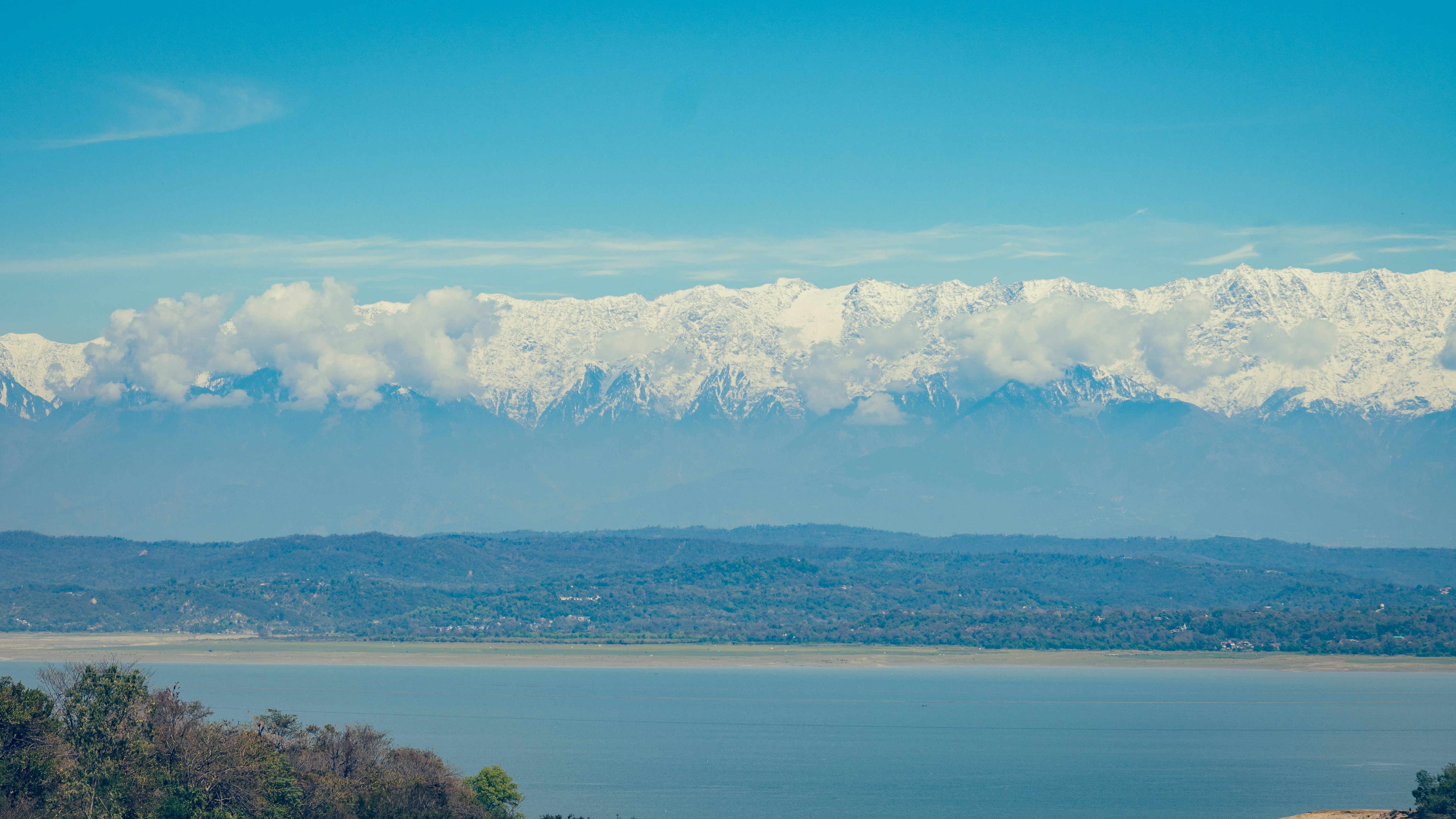 Snow-capped Alps over a tranquil lake