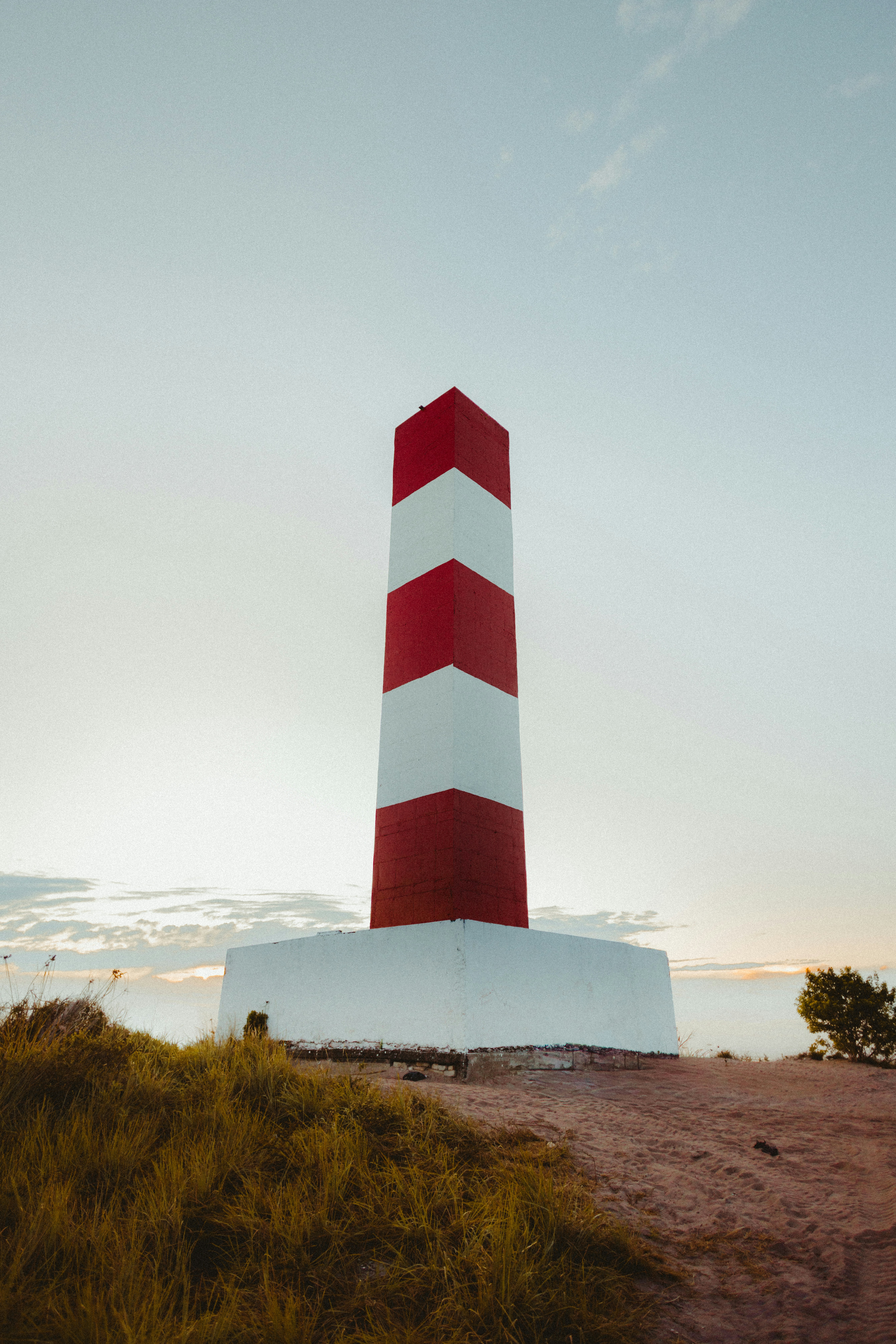 Red-and-White Beacon Reaching Toward the Dusk Sky