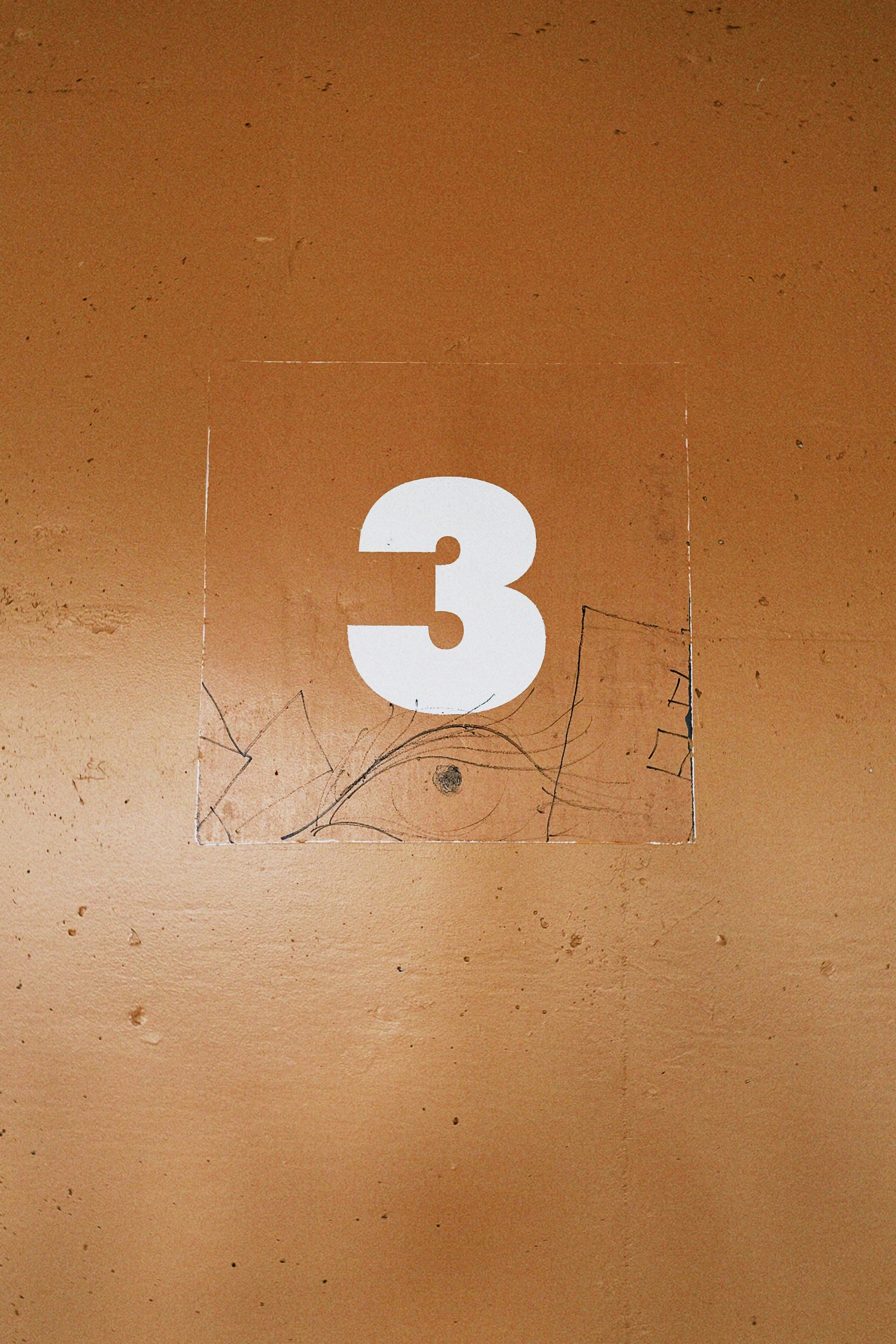 Number 3 on a Weathered Orange Floor