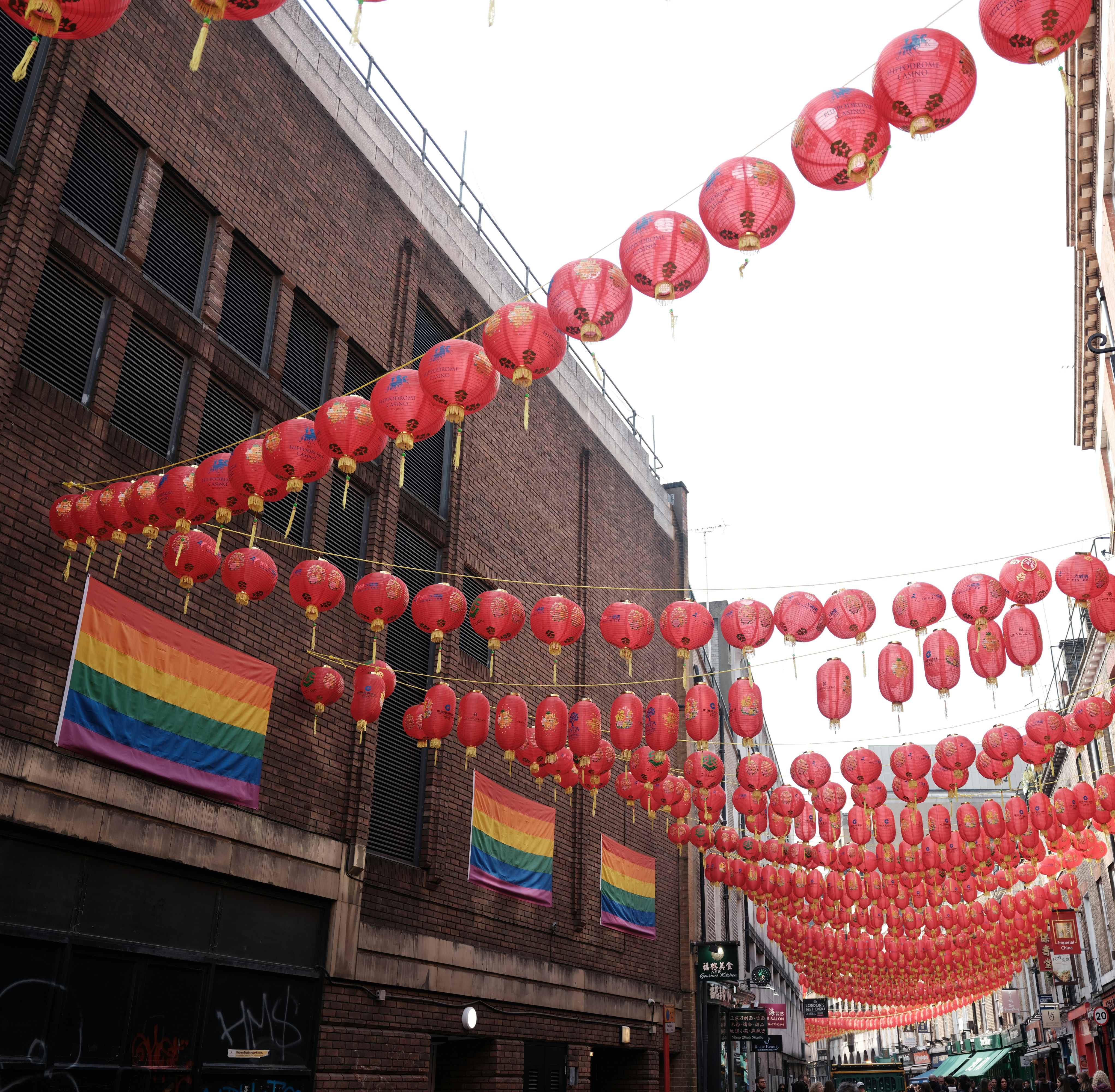 Lantern-lined Street Beneath Rainbow Flags