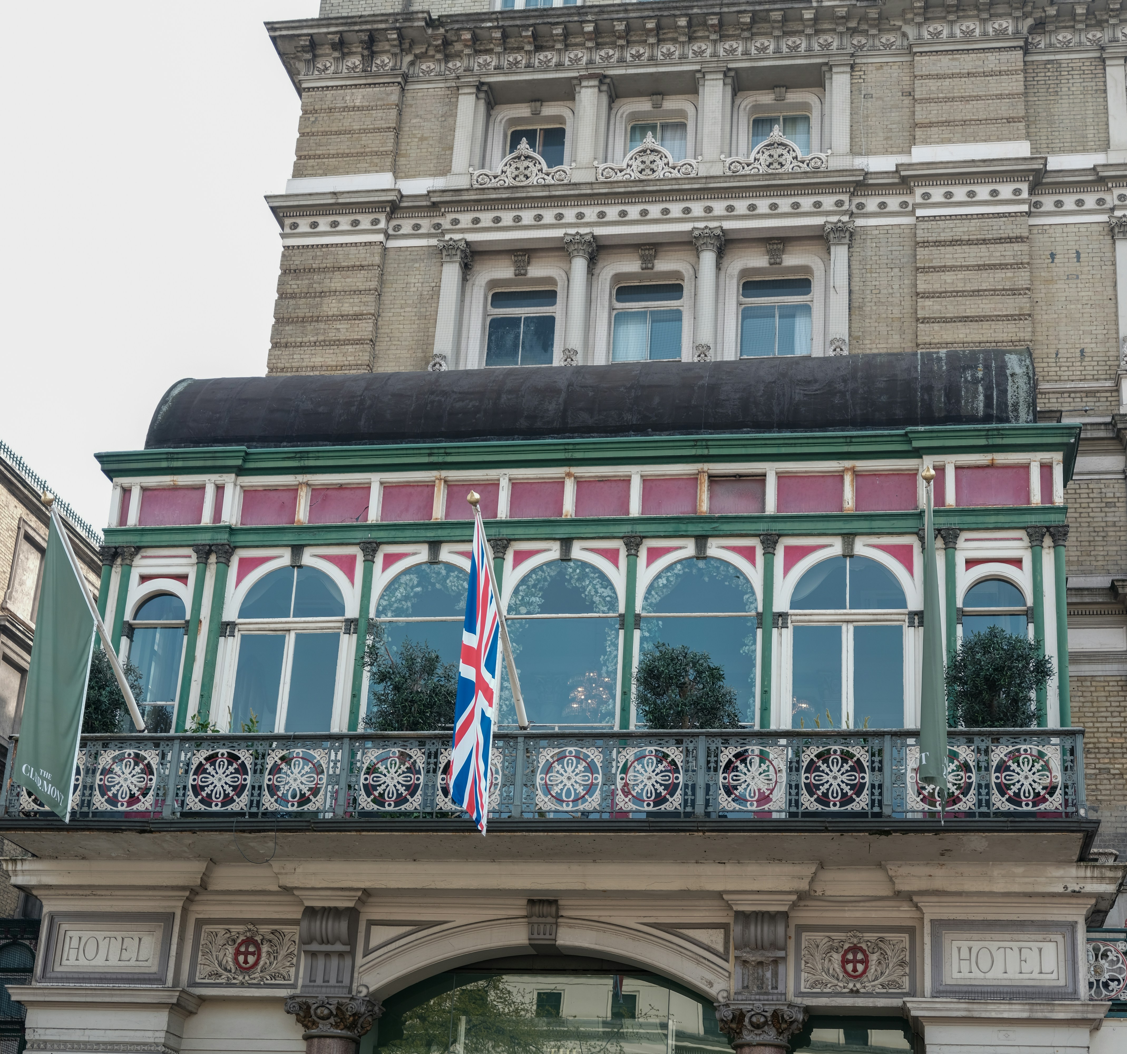 Ornate Hotel Facade with Union Jack Flag Reflection