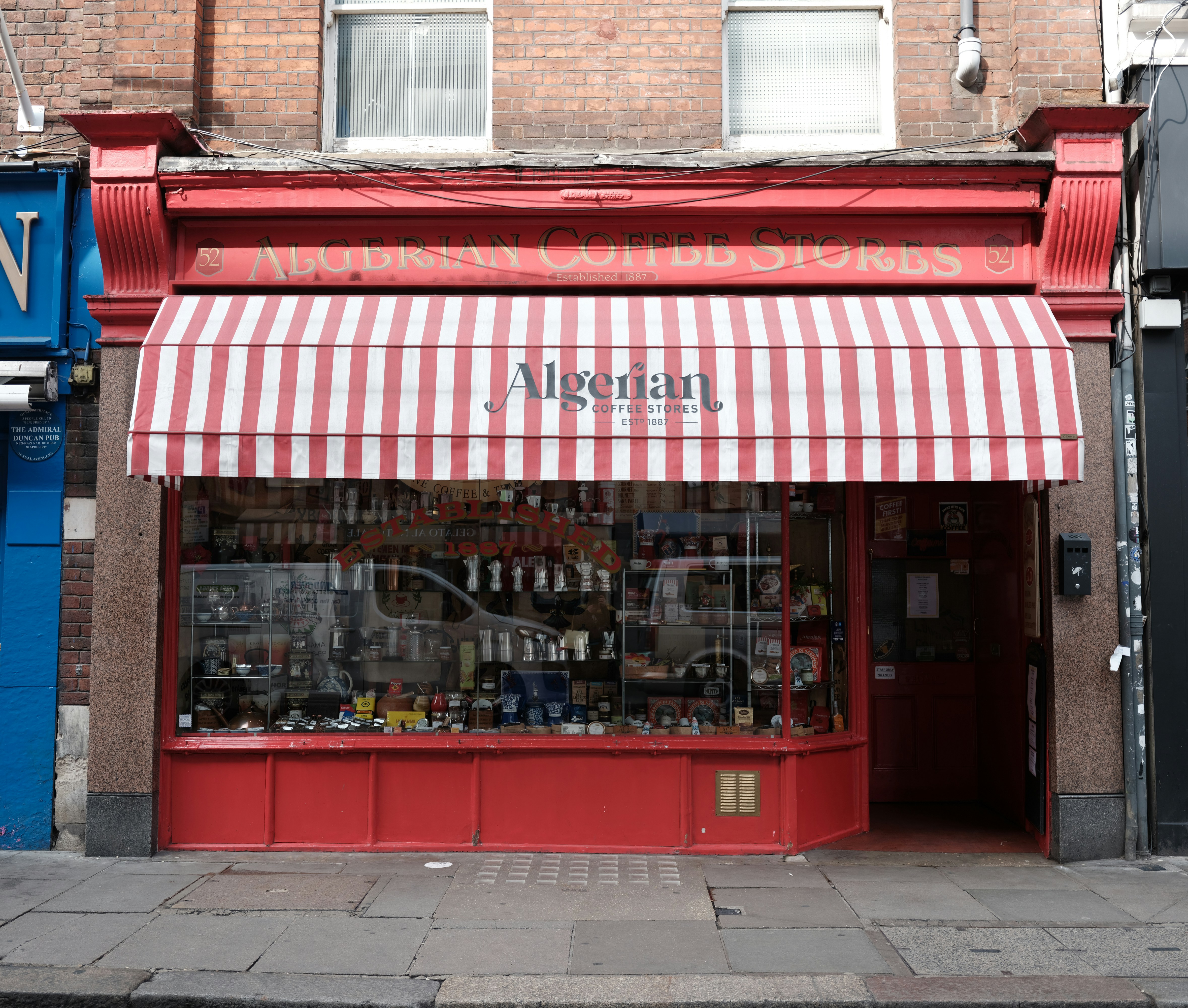 Striped Canopy Over Red-fronted Storefront